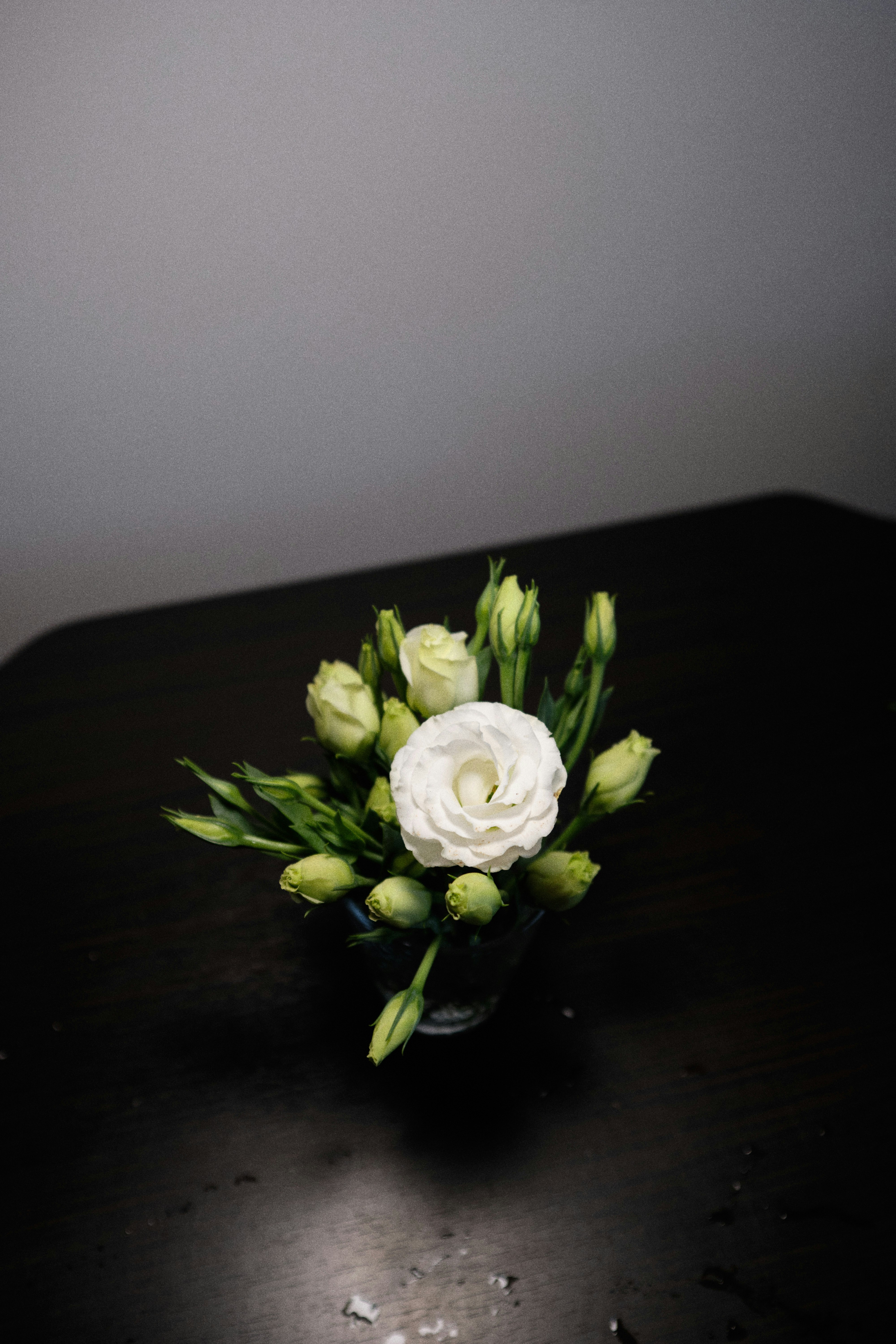 White bloom centerpiece on a dark wooden table