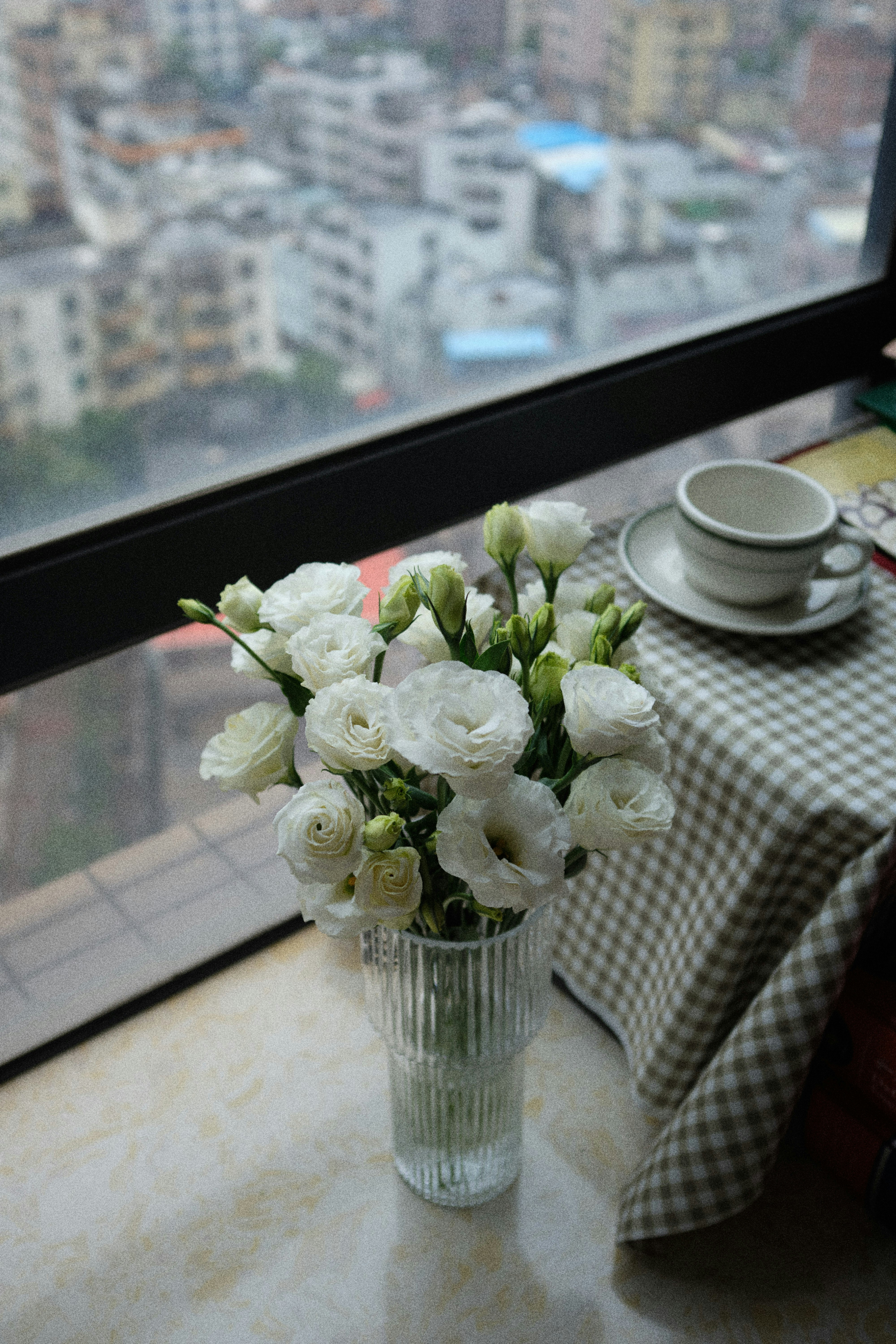 a vase filled with white flowers on top of a table