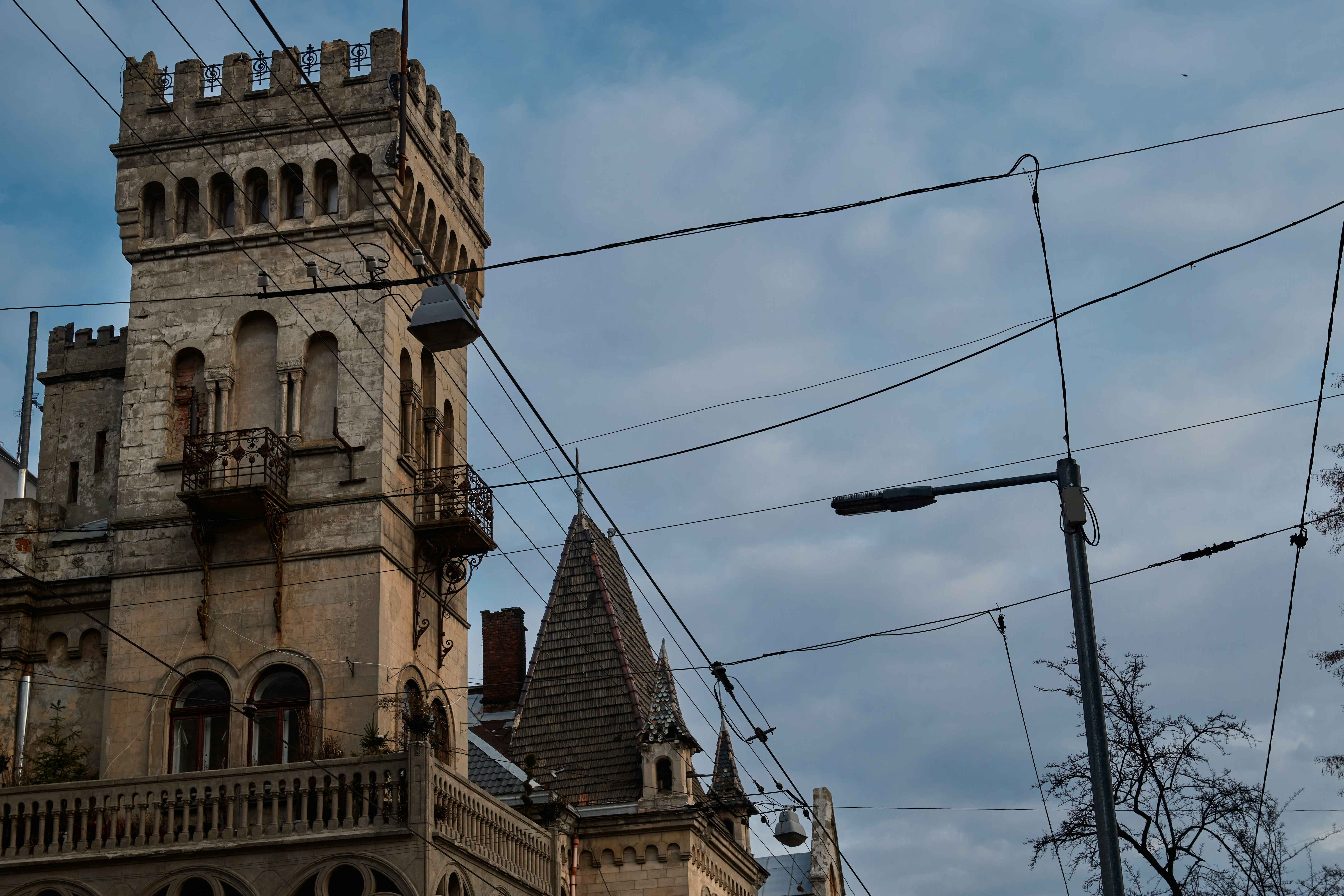 Old Clocktower Facade under a Tangle of Power Lines