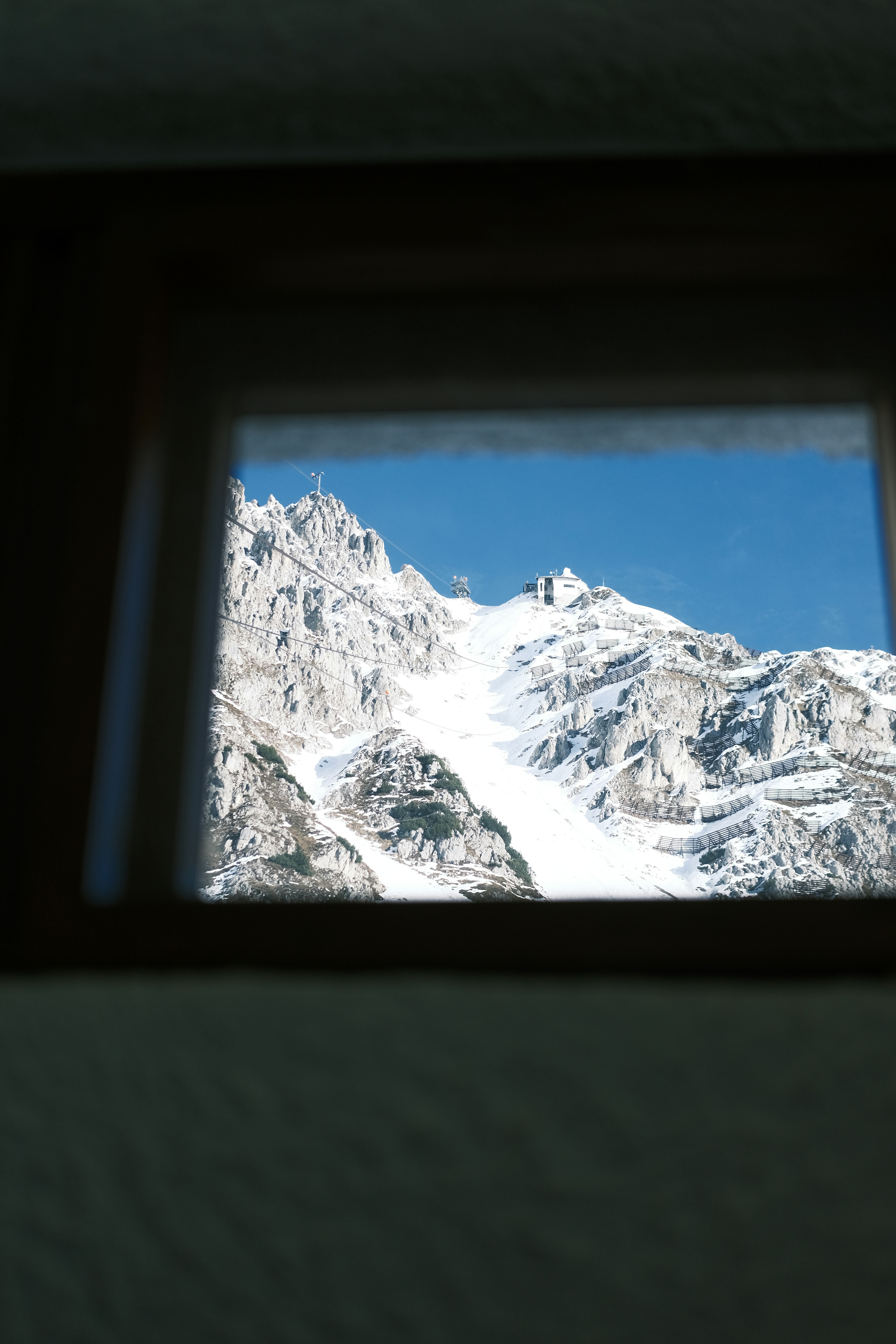 A view of a snowy mountain through a window photo – Free Innsbruck ...