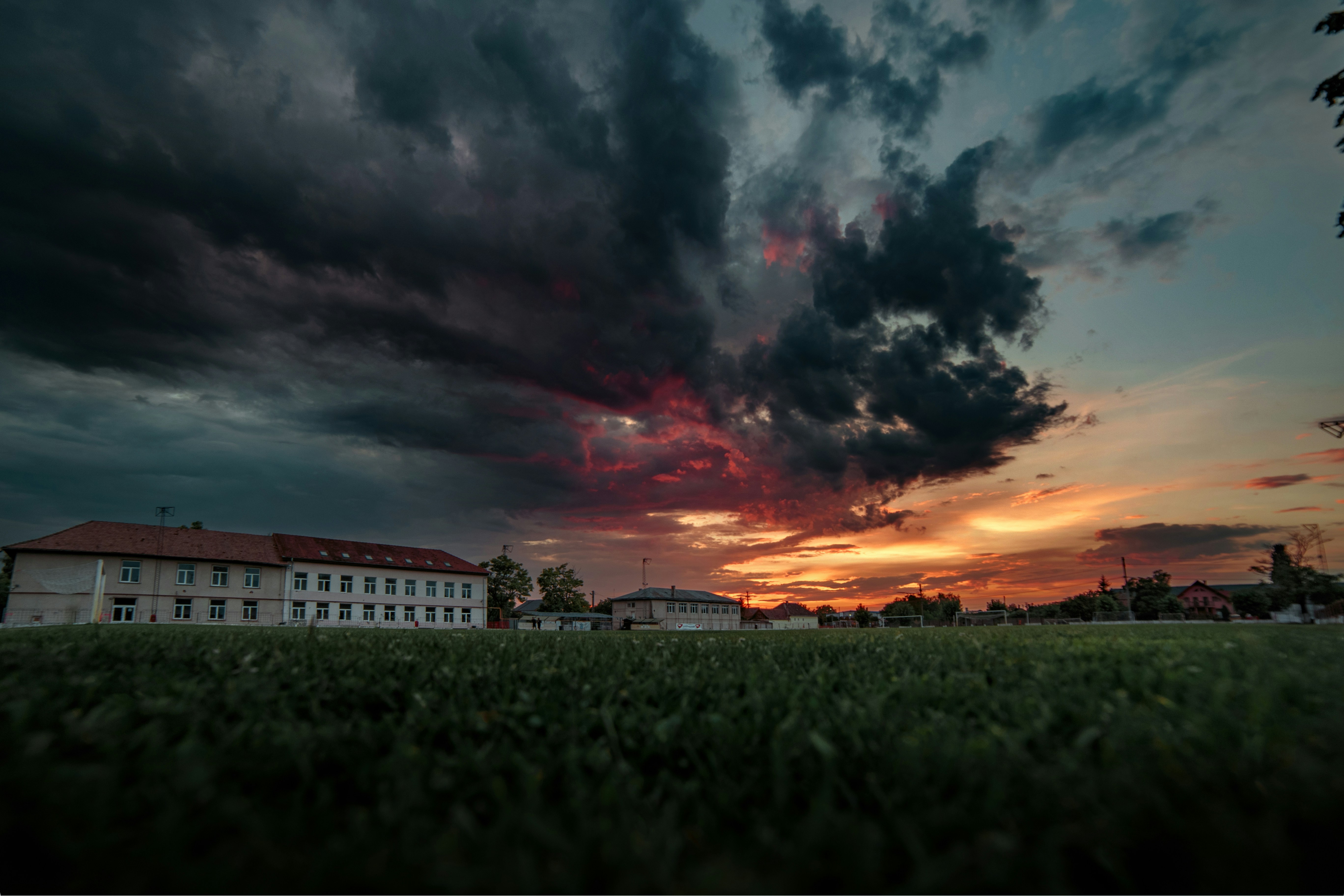 Crimson Horizon Over a Quiet Campus at Dusk