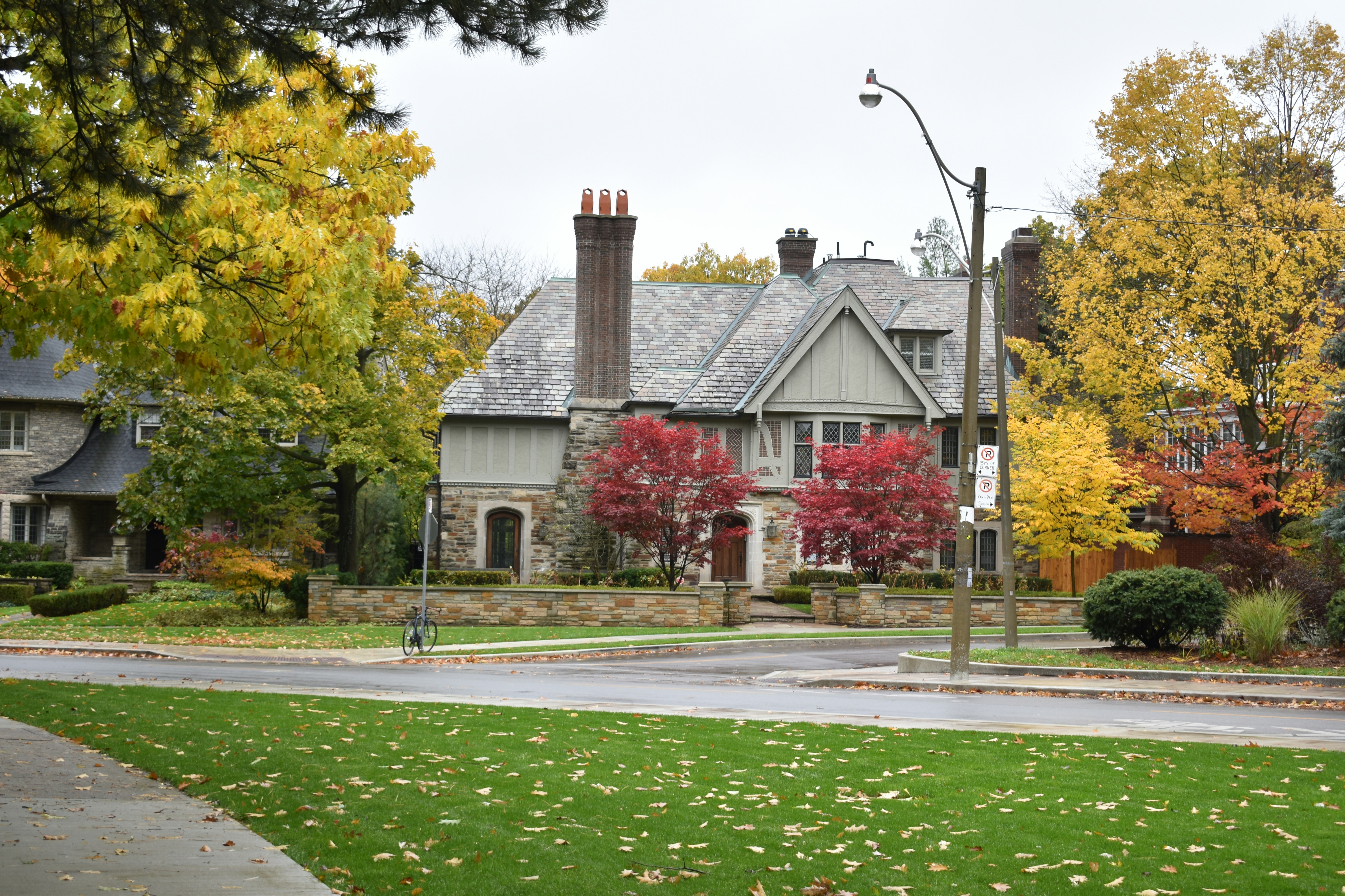 Stone Facade Amid Harvest Hues on a Quiet Street