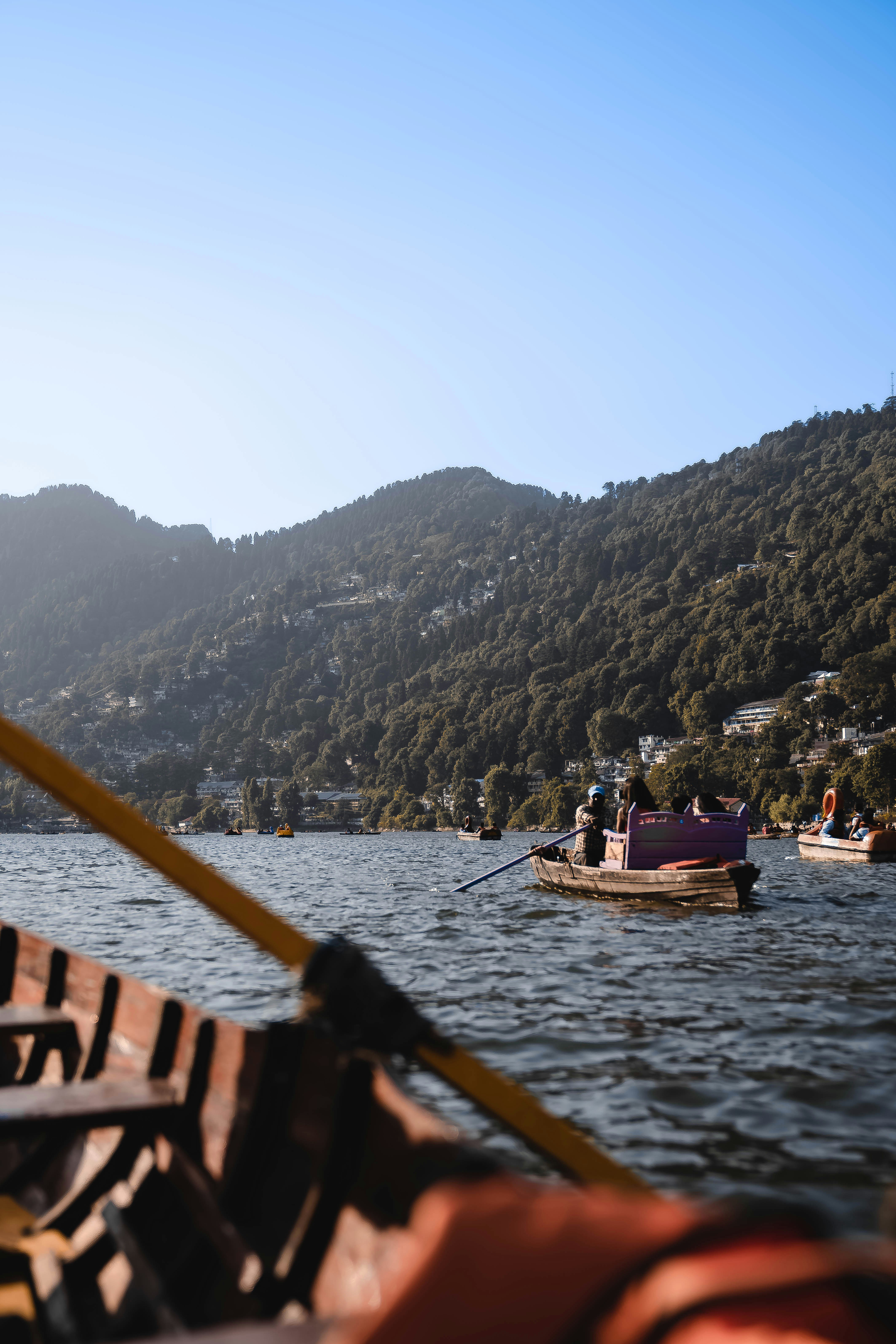 a row boat with people in it on a lake