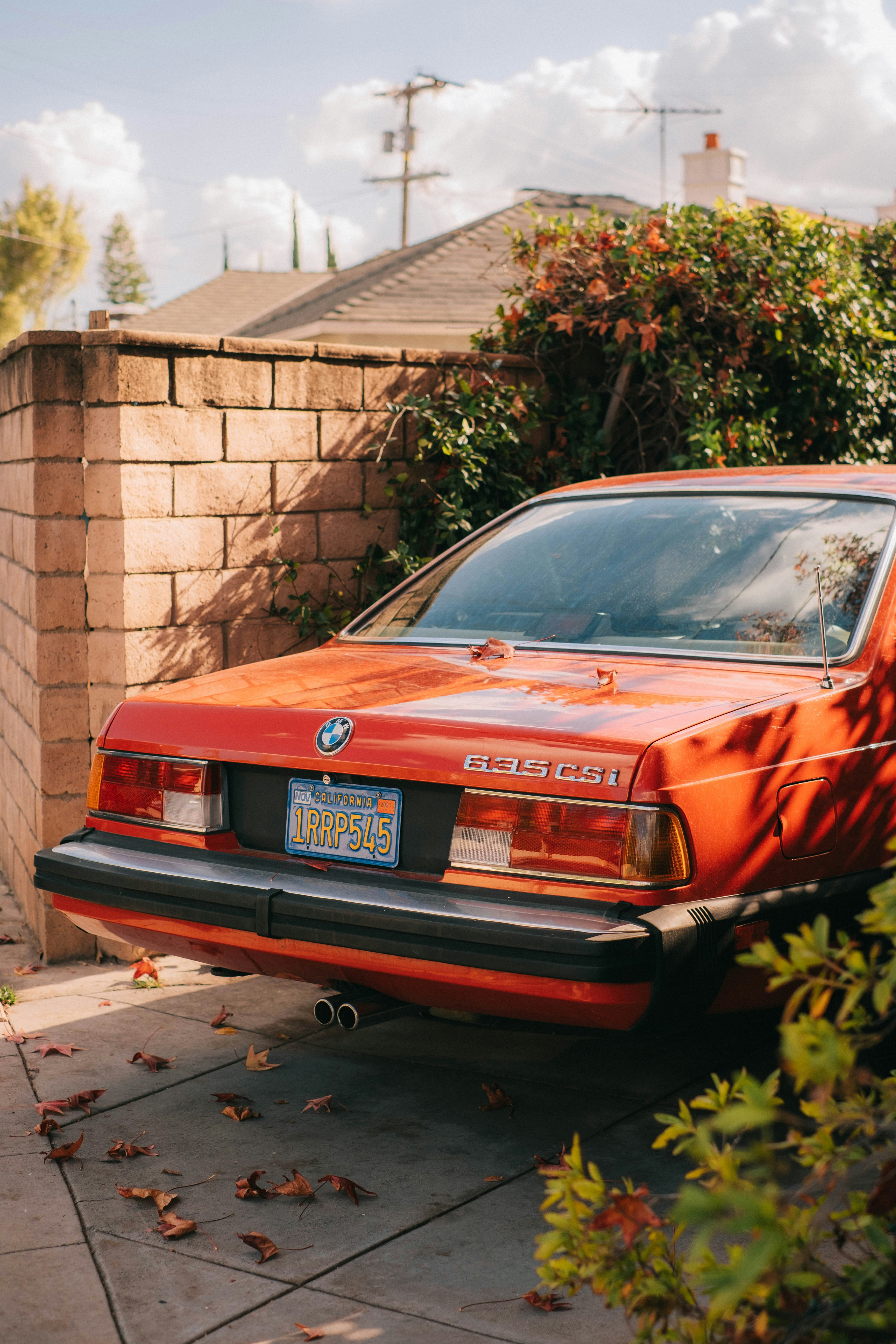 Red BMW in a Quiet Driveway: Sunset Reflections on a Classic