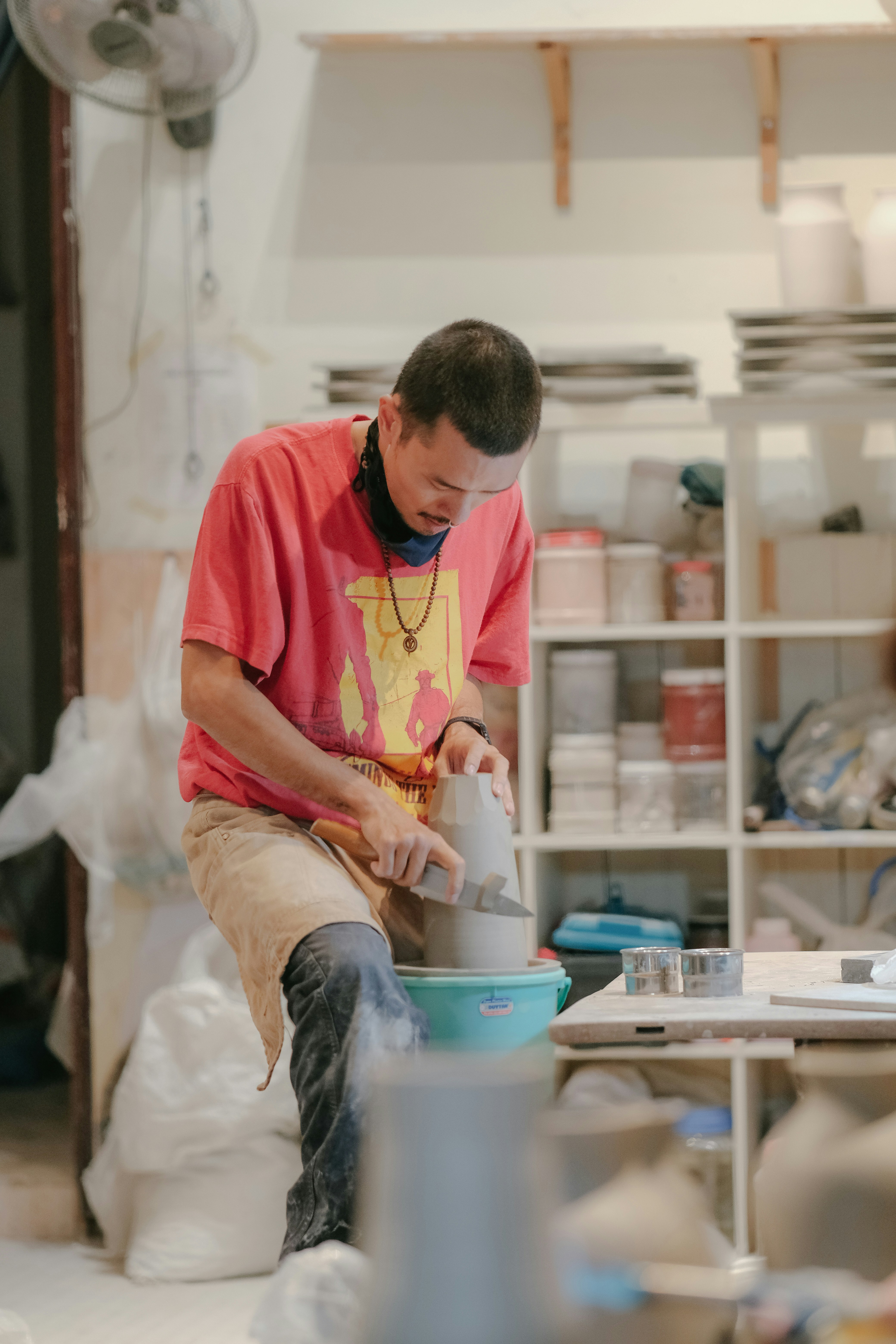 a man is pouring something into a blue bowl