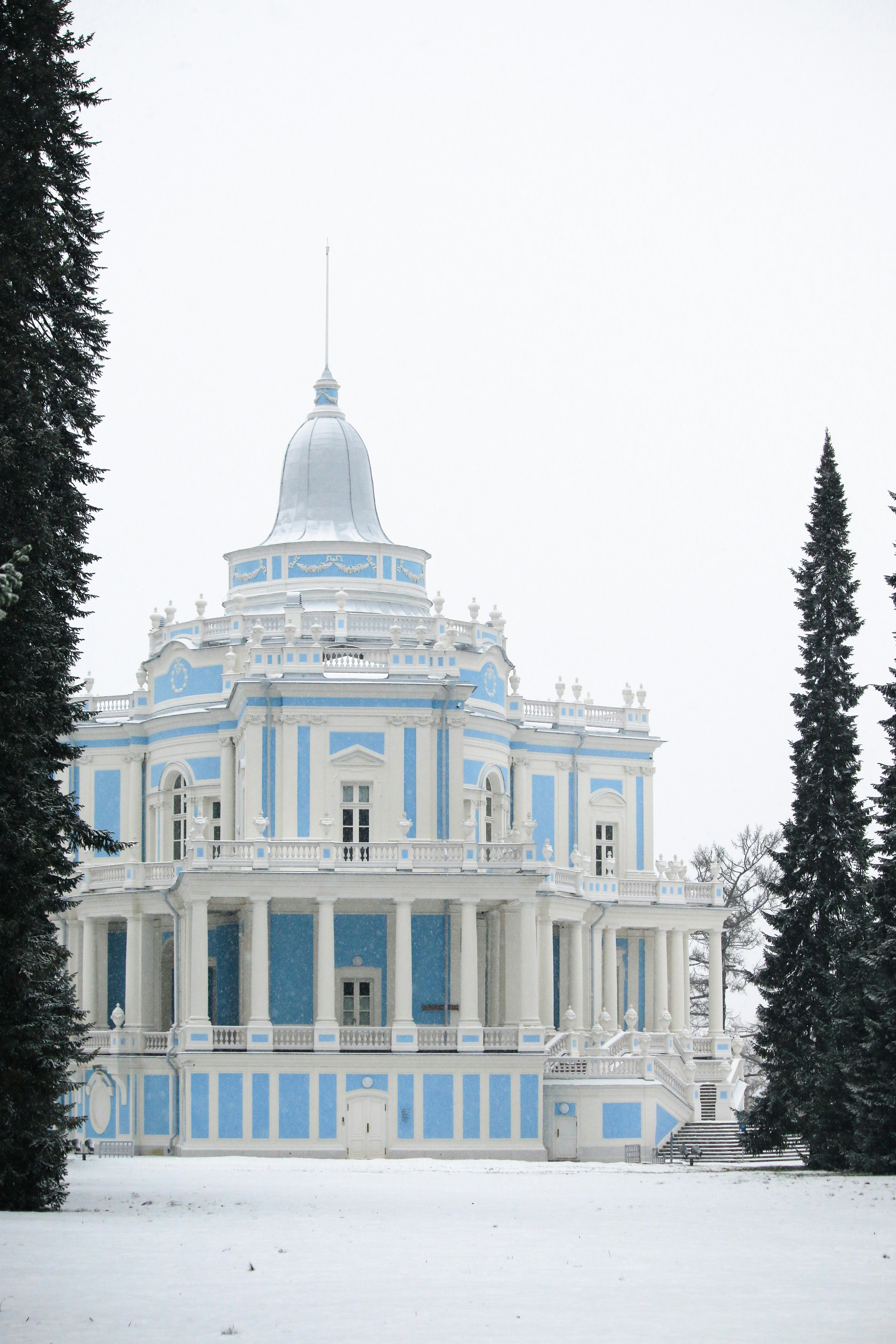A large blue and white building surrounded by trees photo – Free Travel ...