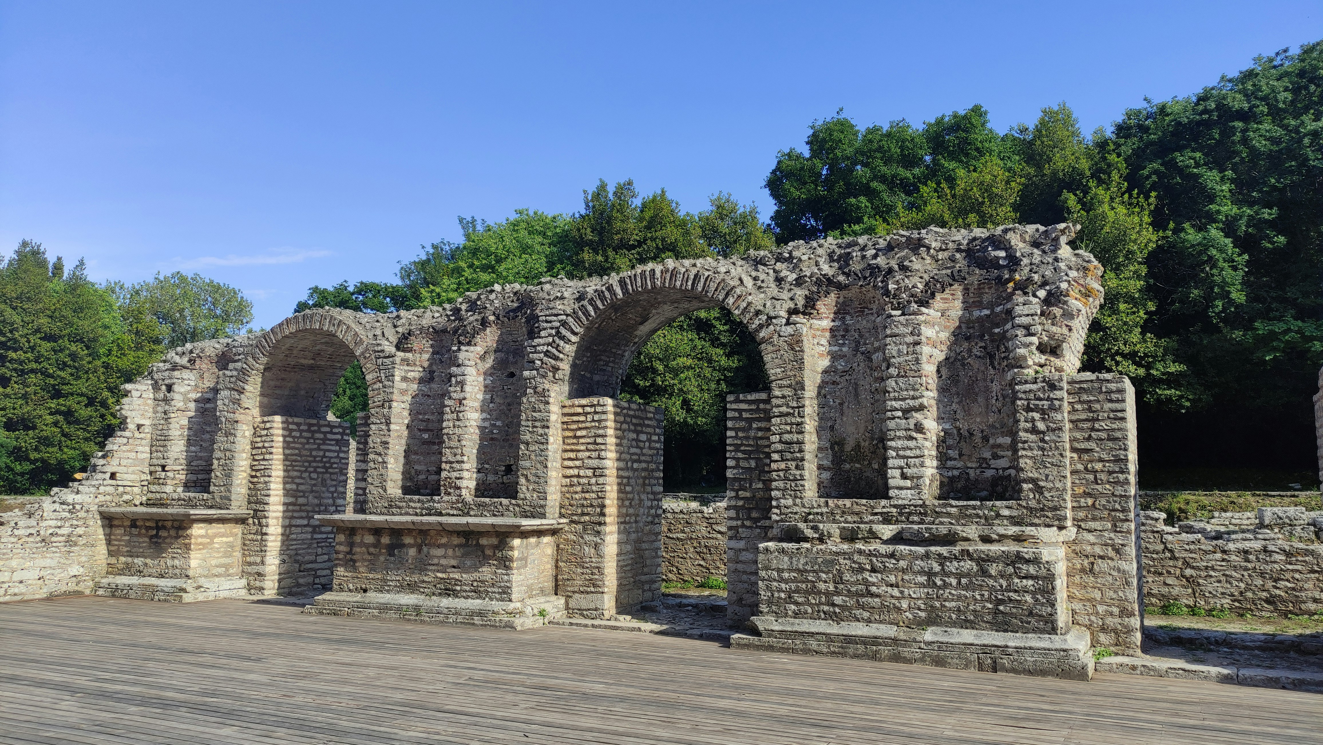 Stone Arcades at Midday: Time-Worn Gateways in a Quiet Park