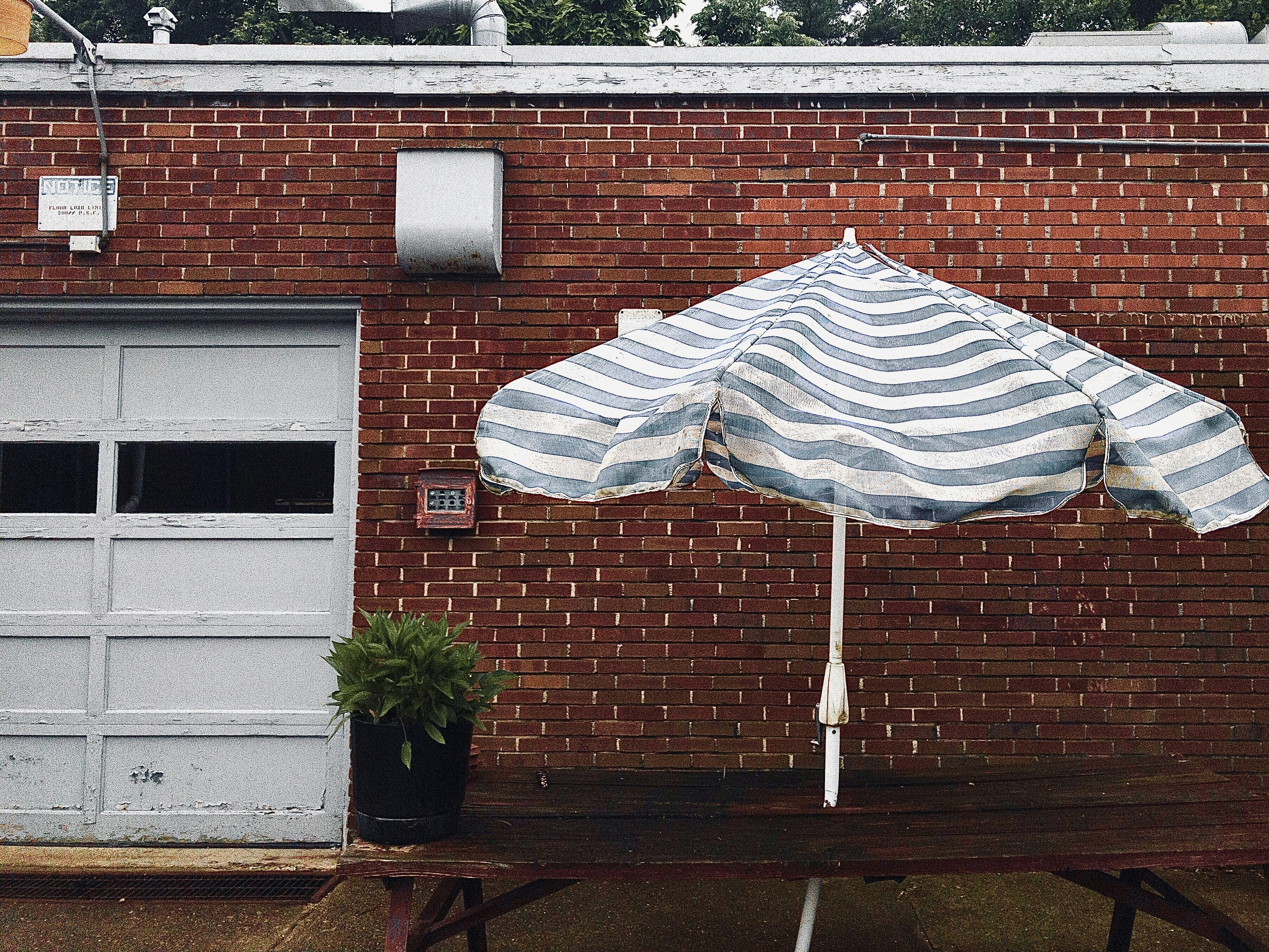 Striped Parasol on a Brick Terrace: Quiet Urban Shade