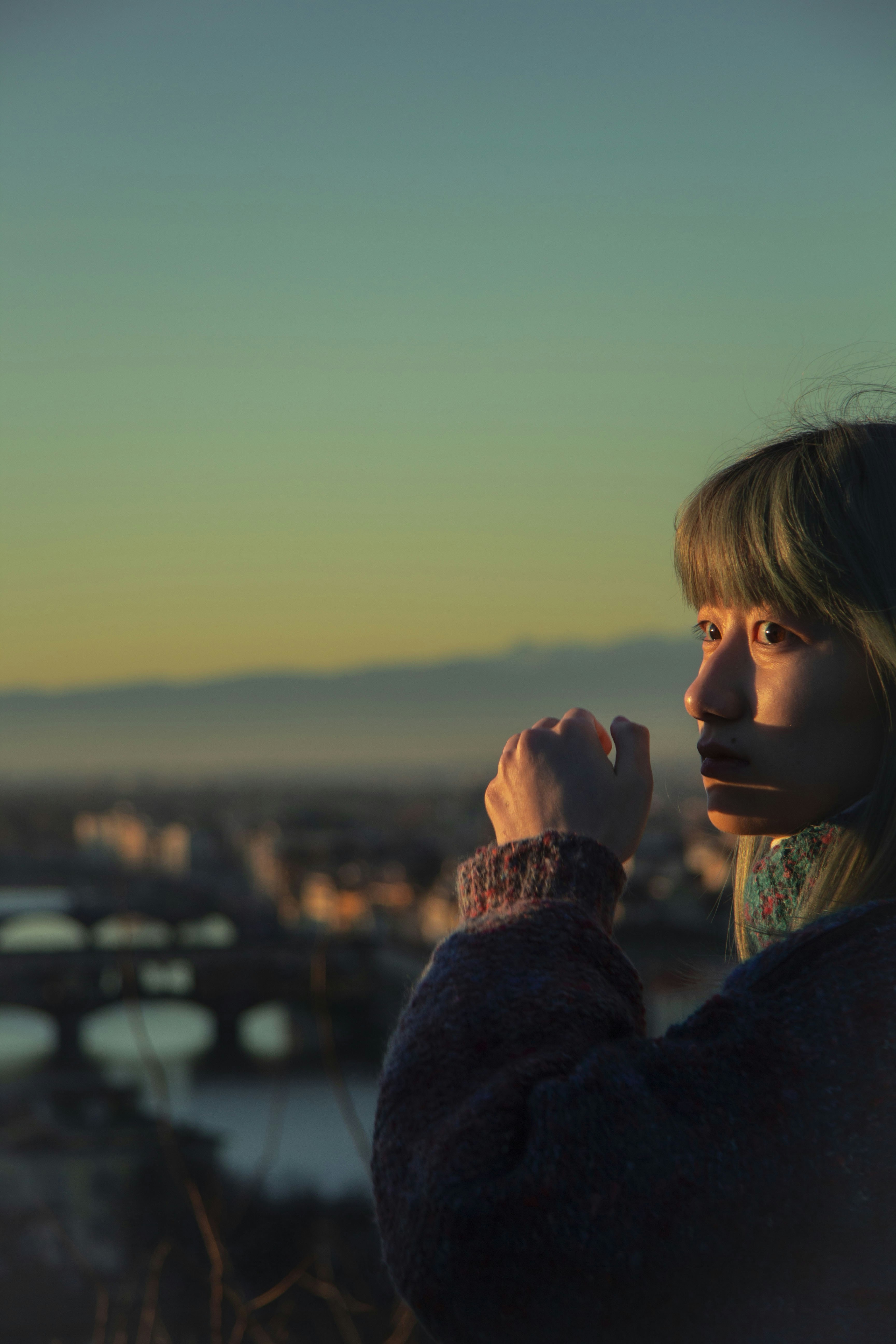 a woman standing in front of a city skyline
