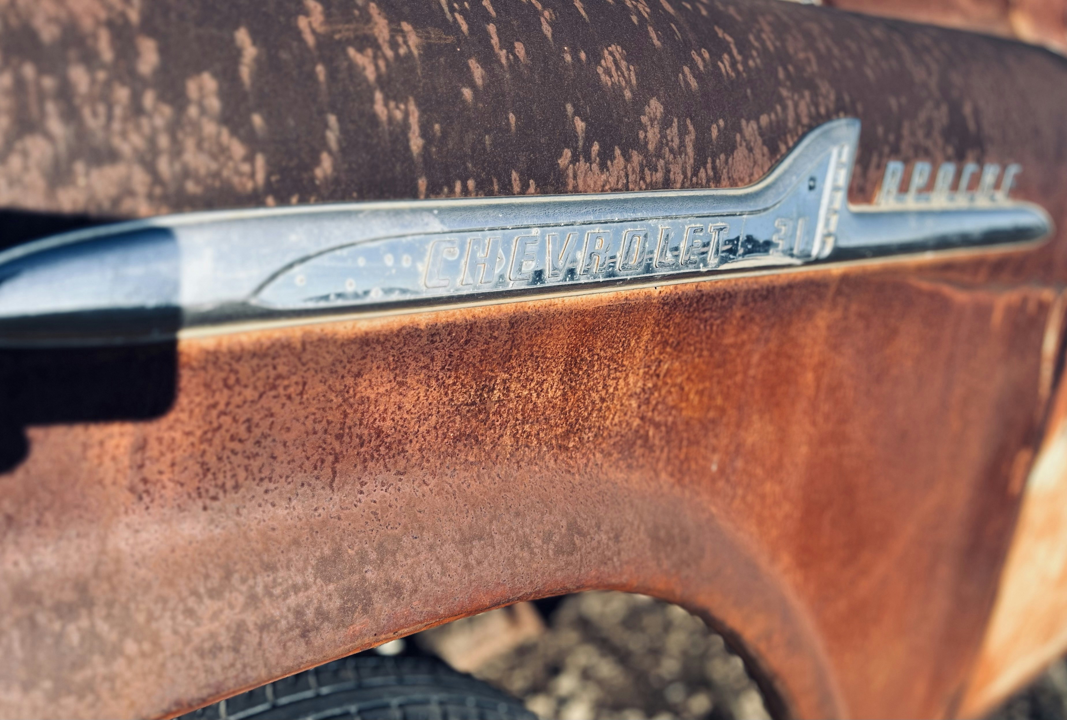 a close up of a rusted out car door handle