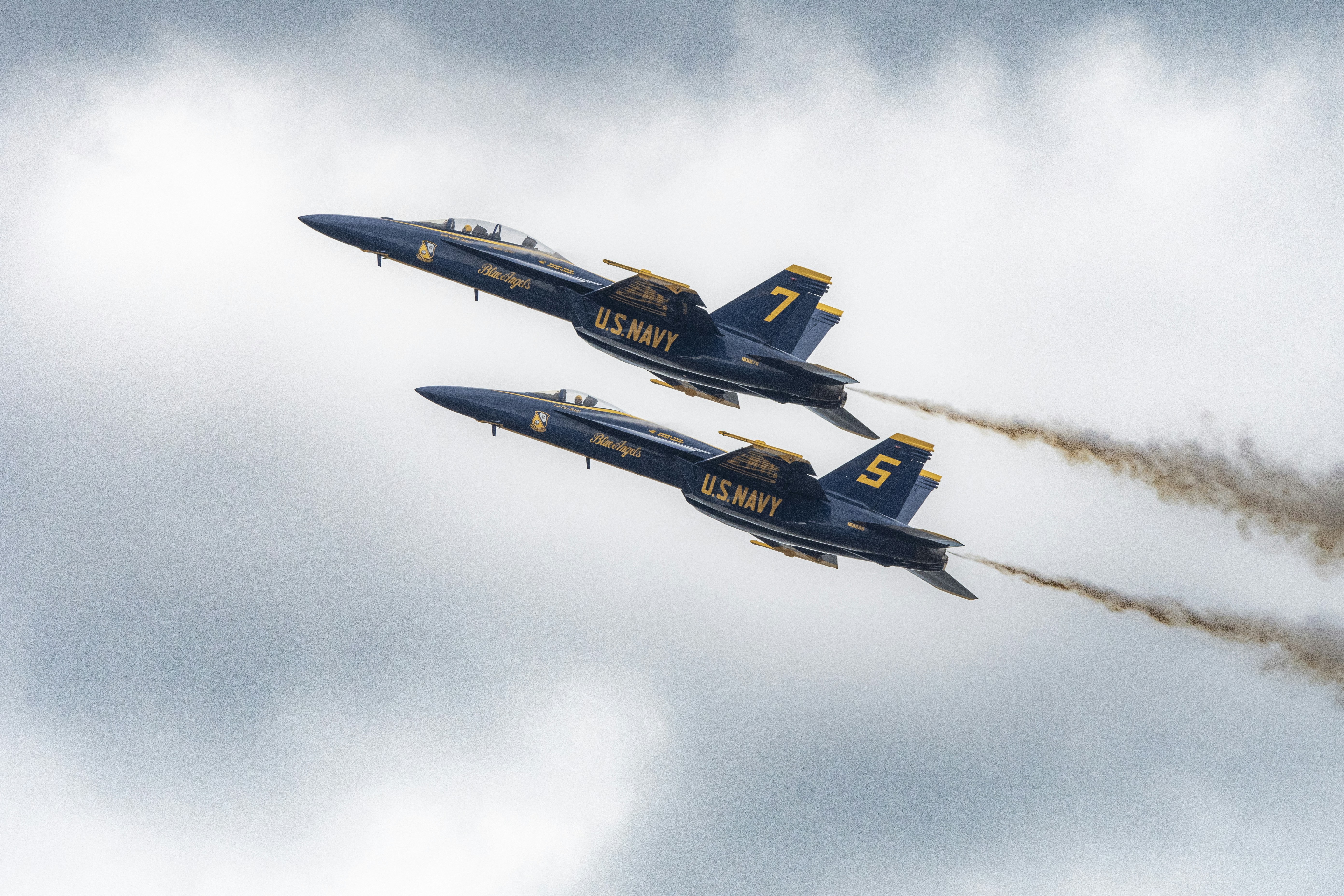 Two jets flying in the sky leaving a trail of smoke behind them photo ...