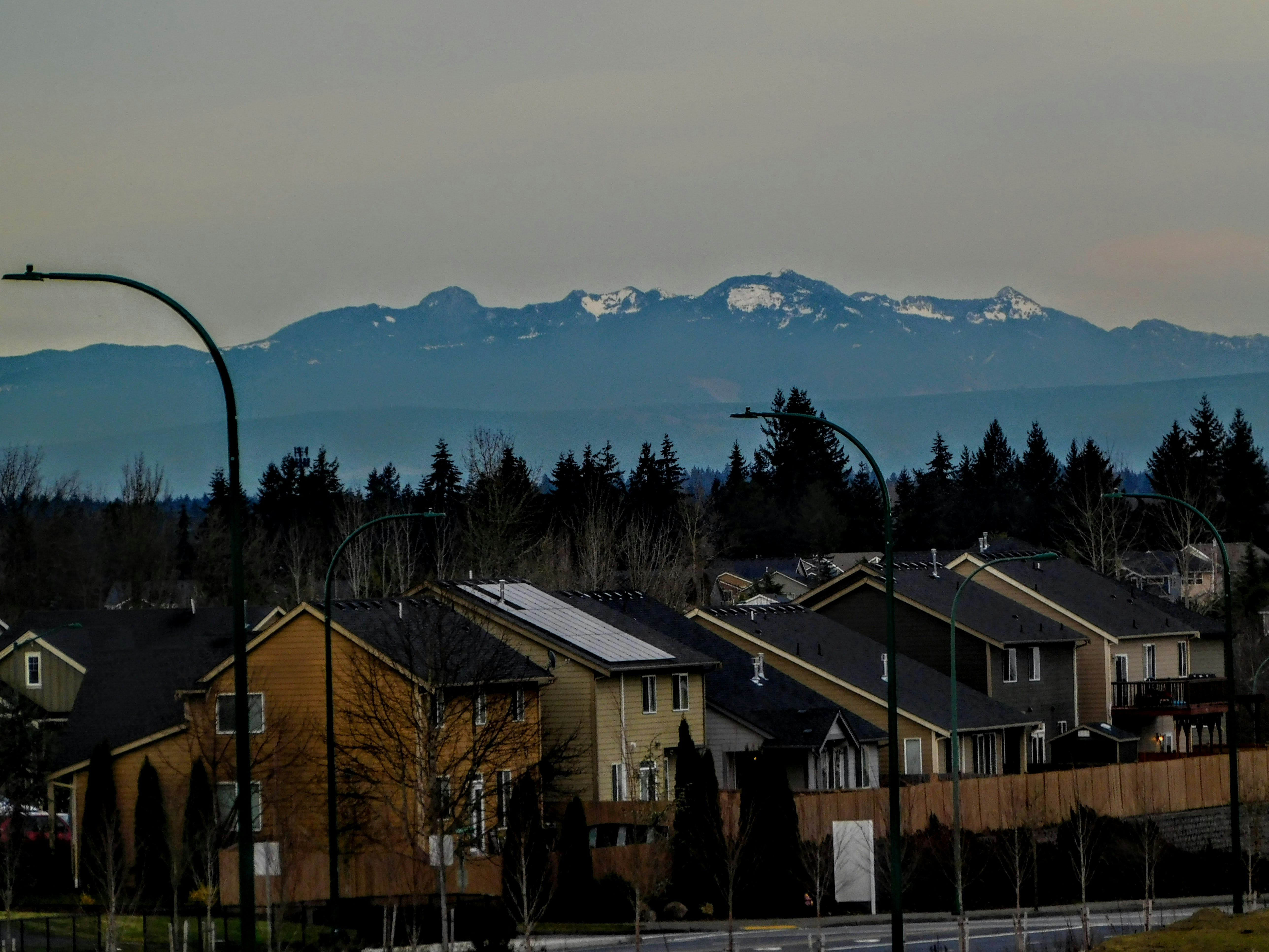 Snow-Kissed Ridge Framing a Suburban Dusk