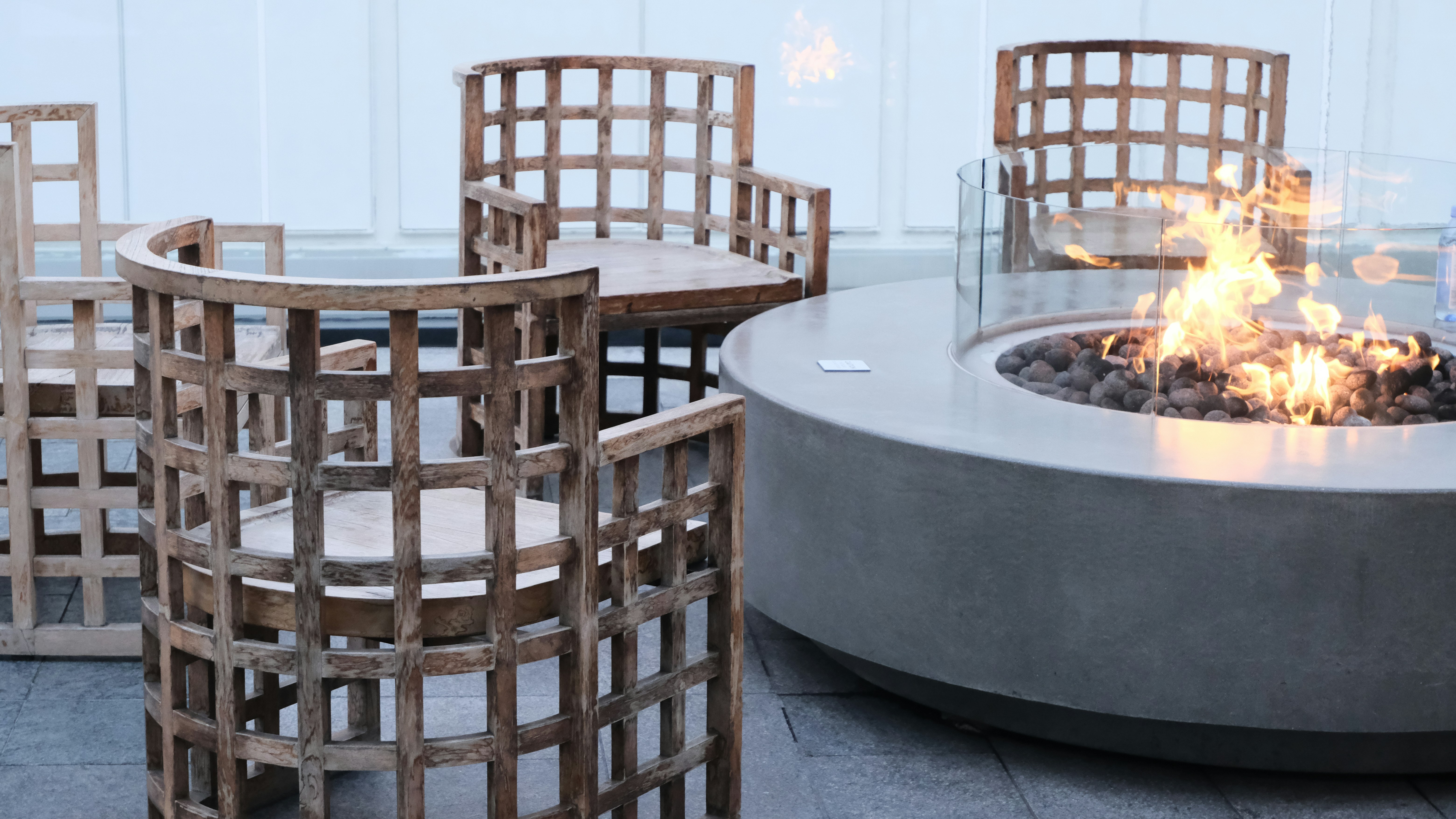 Firelit Circle: Latticed Chairs Embrace a Cozy Terrace