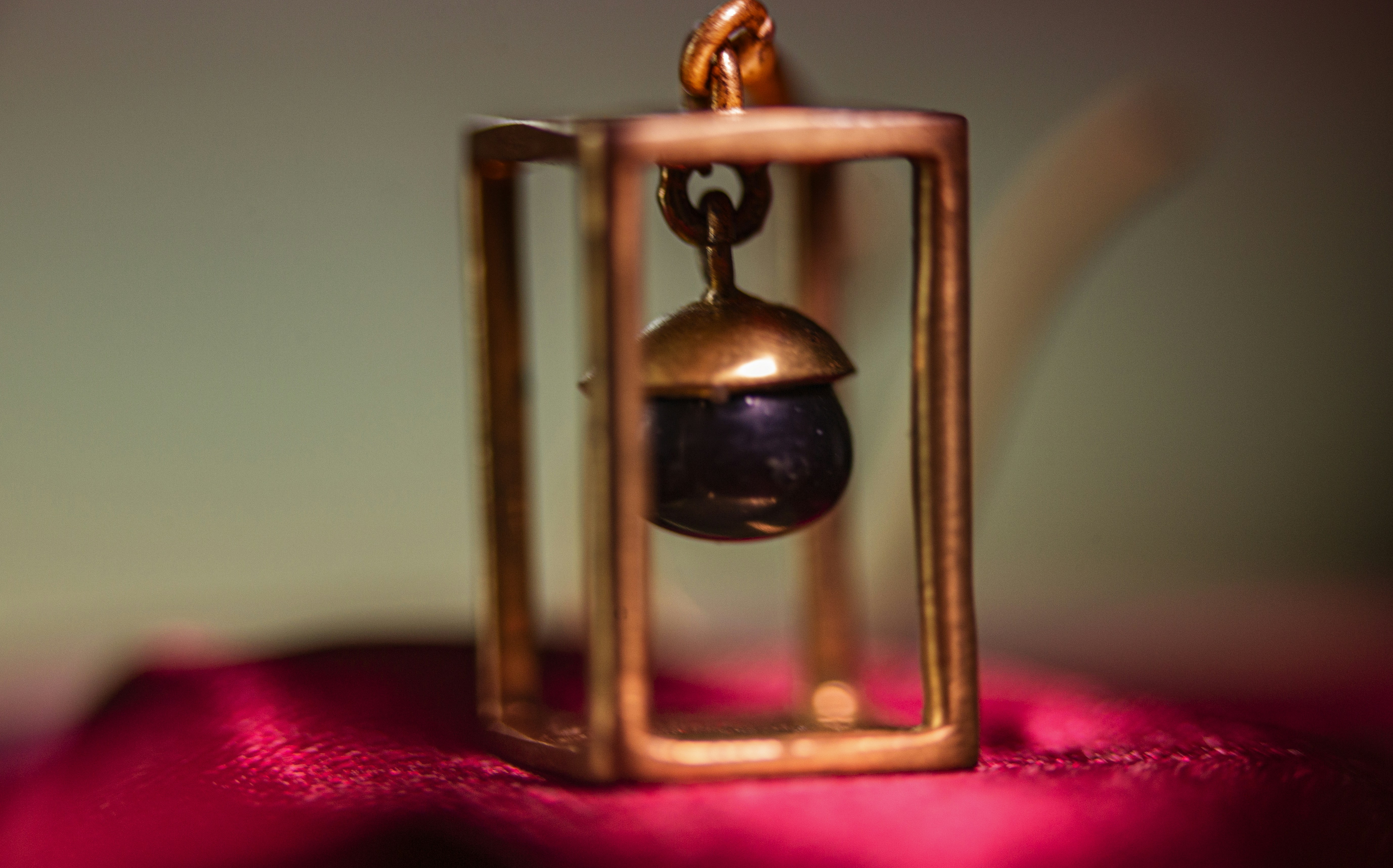 Midnight Orb Cradled in a Copper Frame on Velvet Crimson