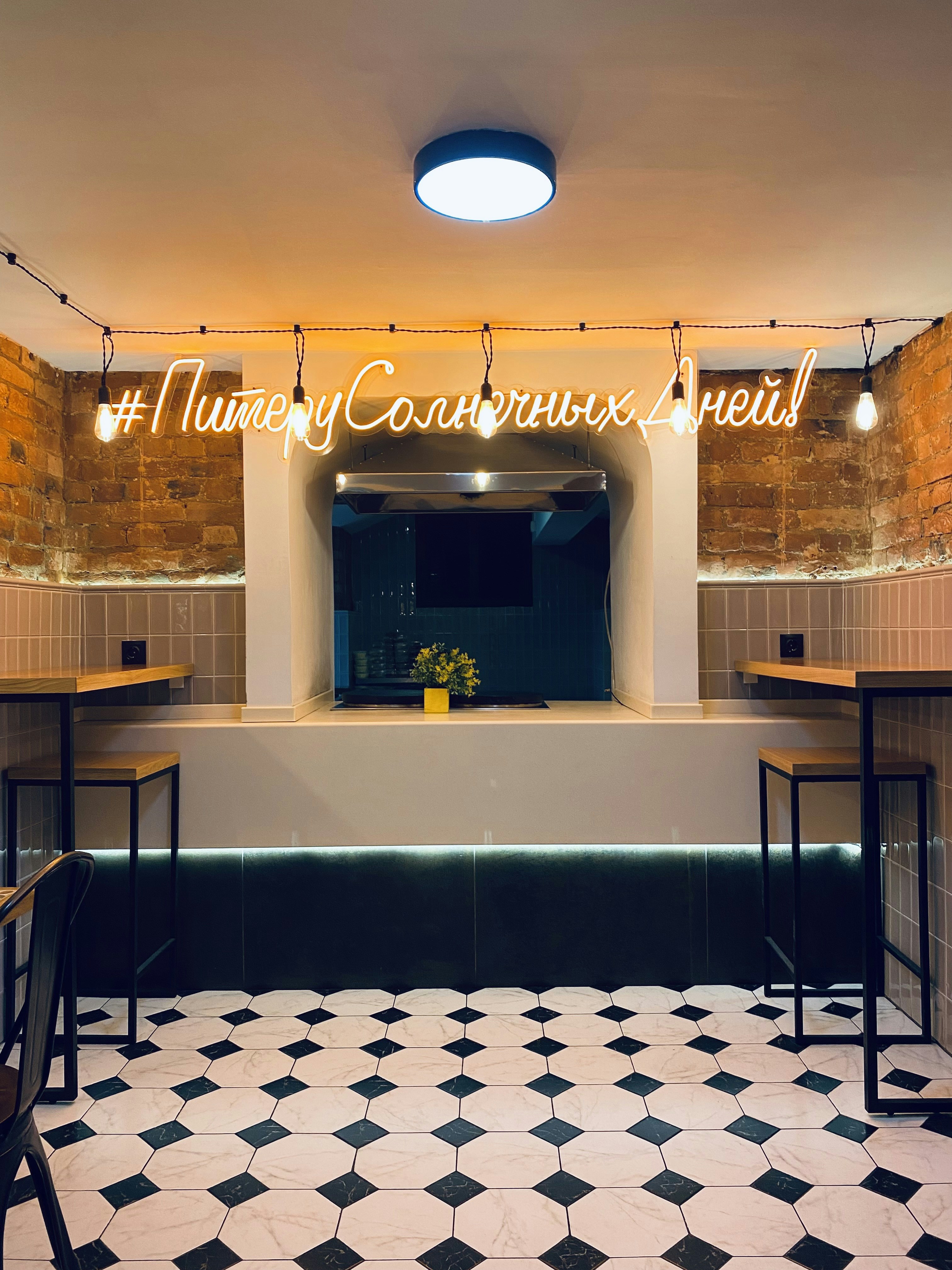 Neon Hashtag Over a Brick-Walled Café Counter