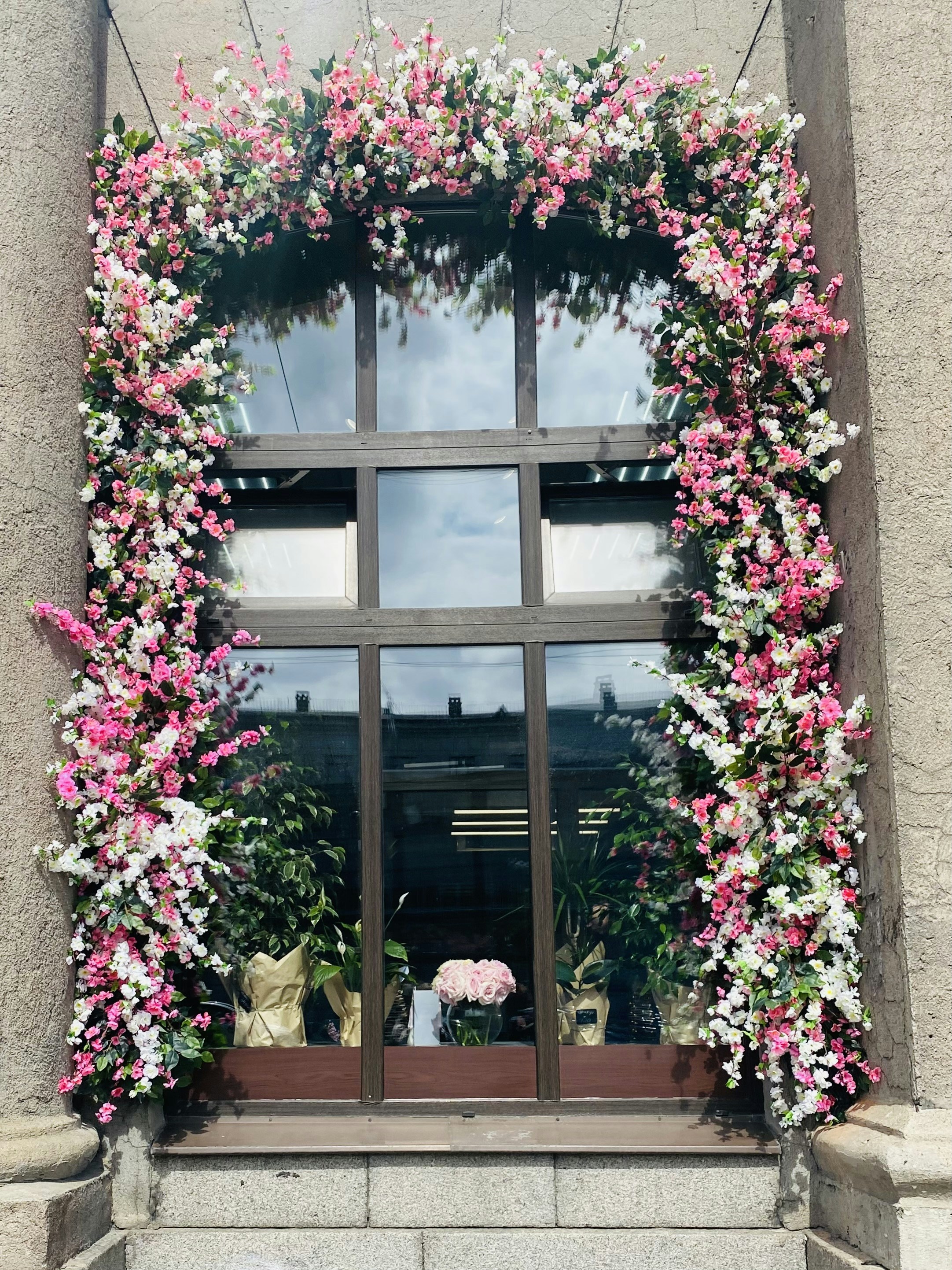 Petaled Arch Framing a Floral Window Display