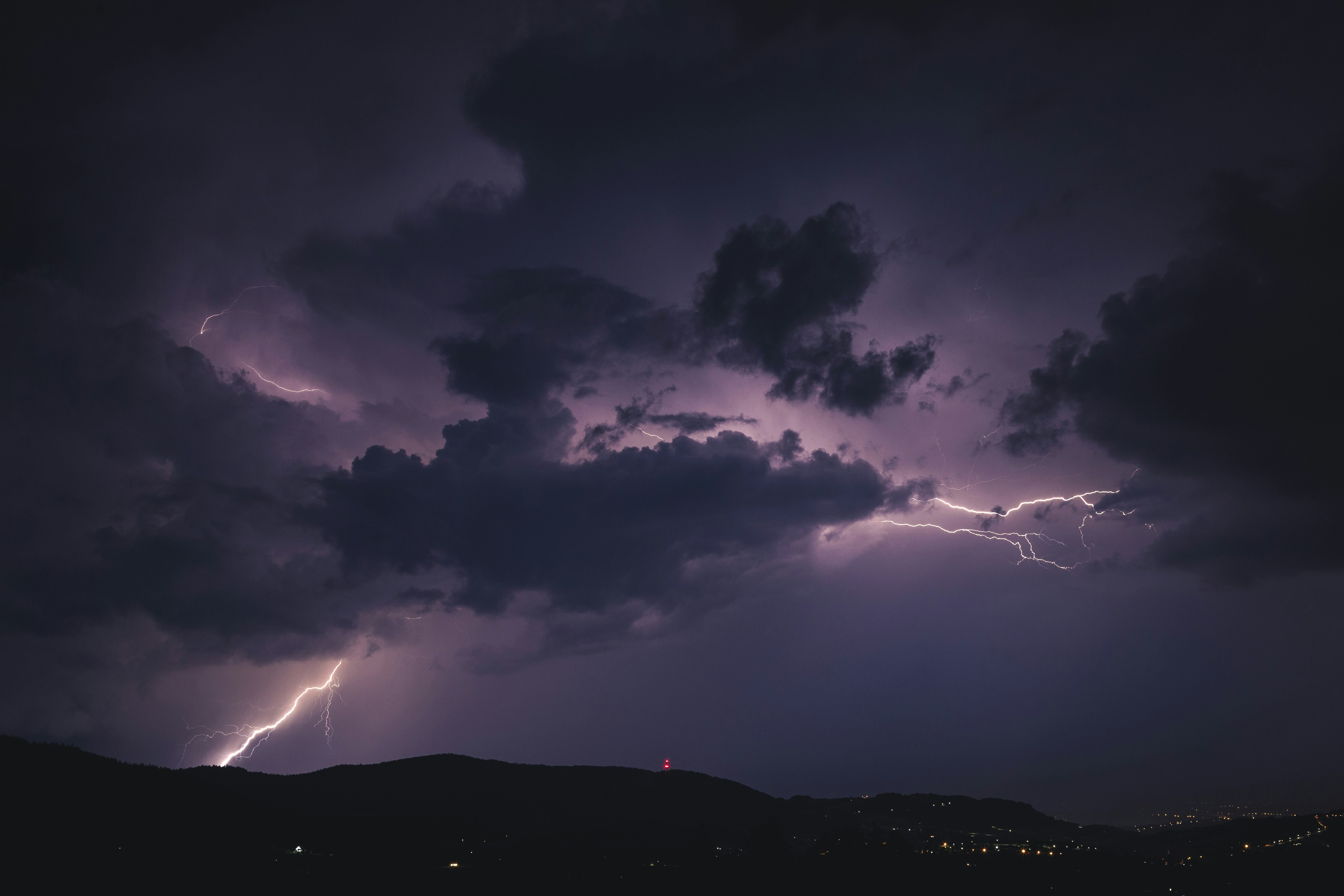 A lightning storm is seen over a city at night photo – Free Poland ...