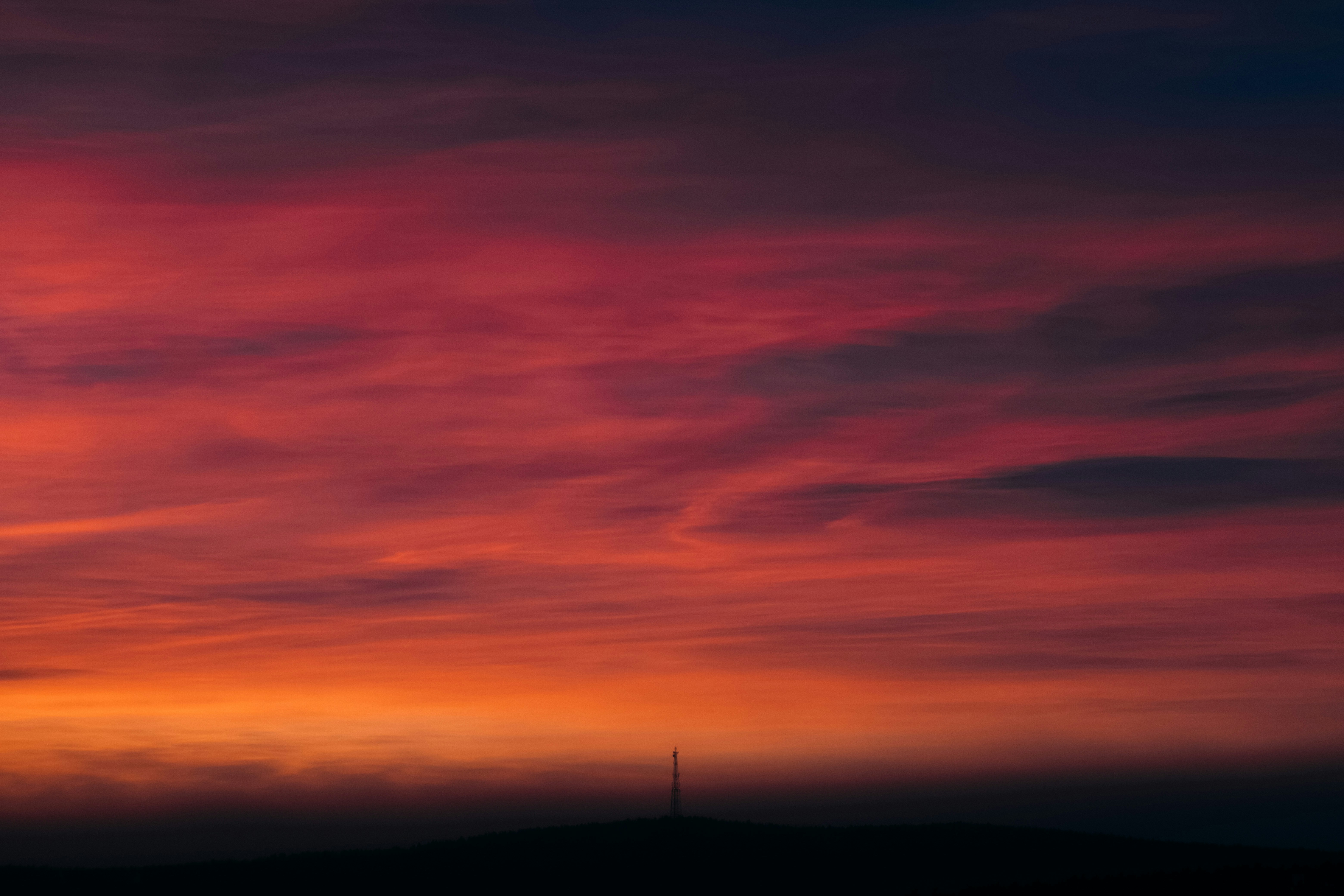 Silhouette at Dusk: A Thin Ledge Recedes into the Horizon