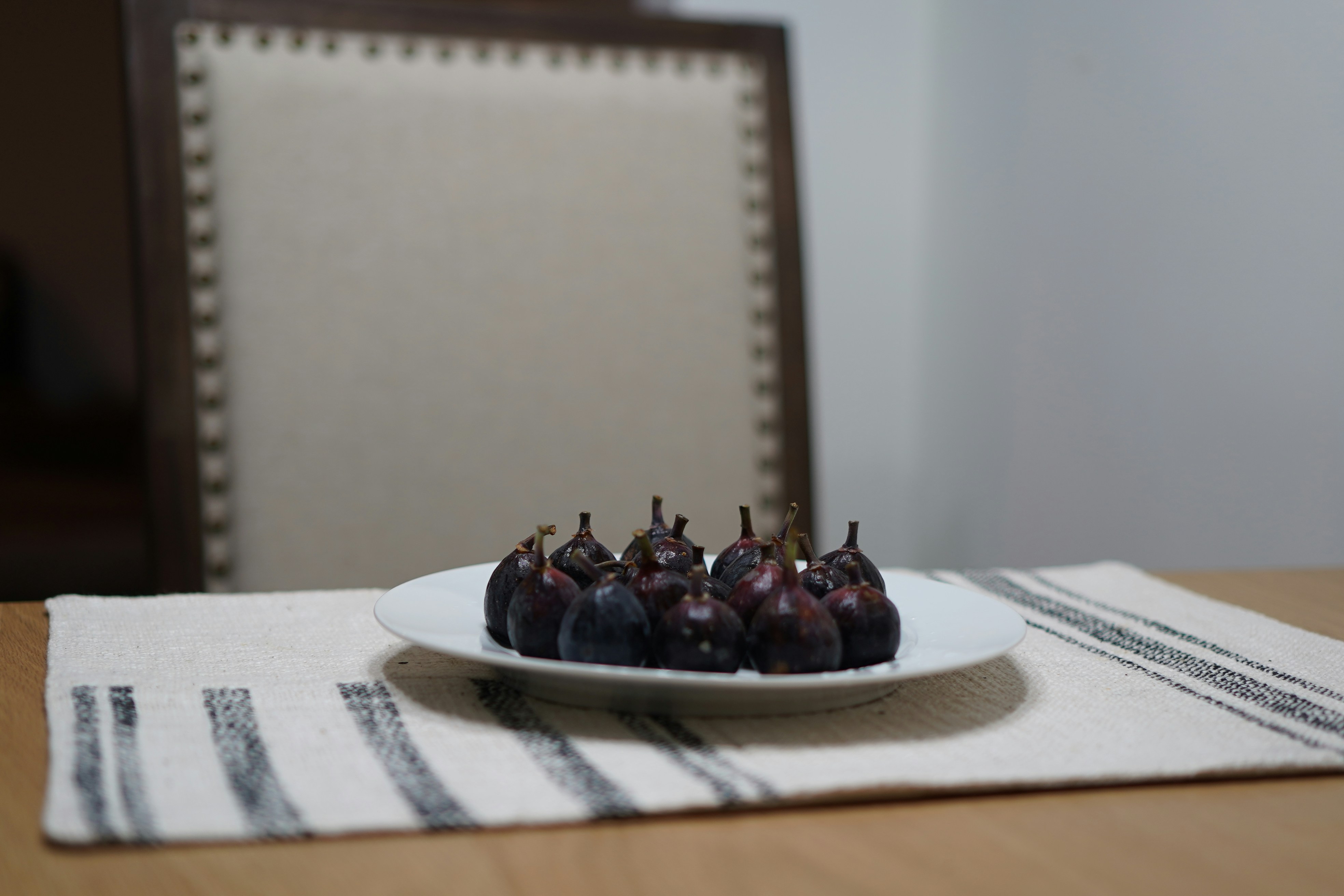a white plate topped with figurines on top of a wooden table