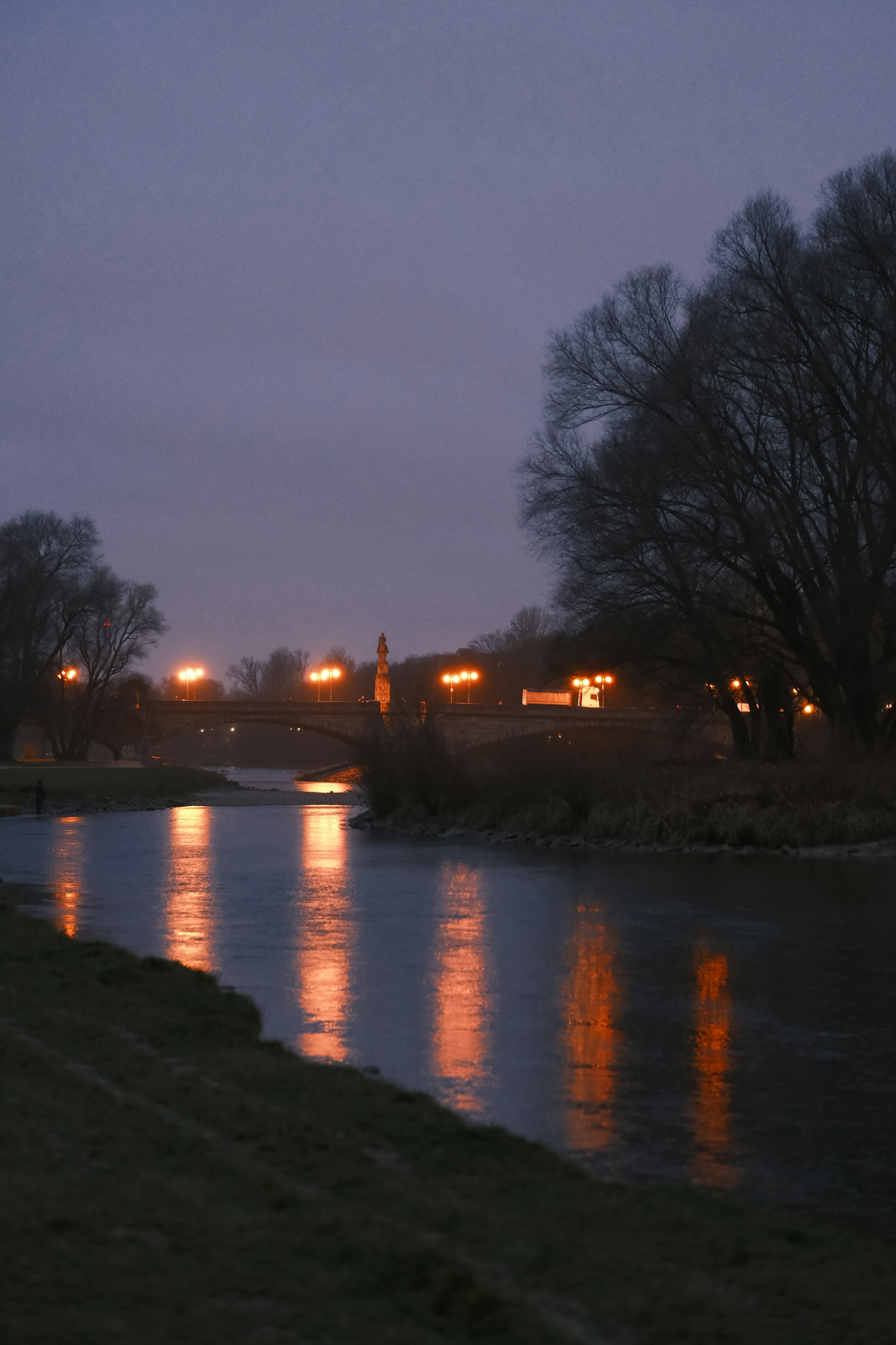 Amber Echoes on the River Under a Quiet Dusk Bridge