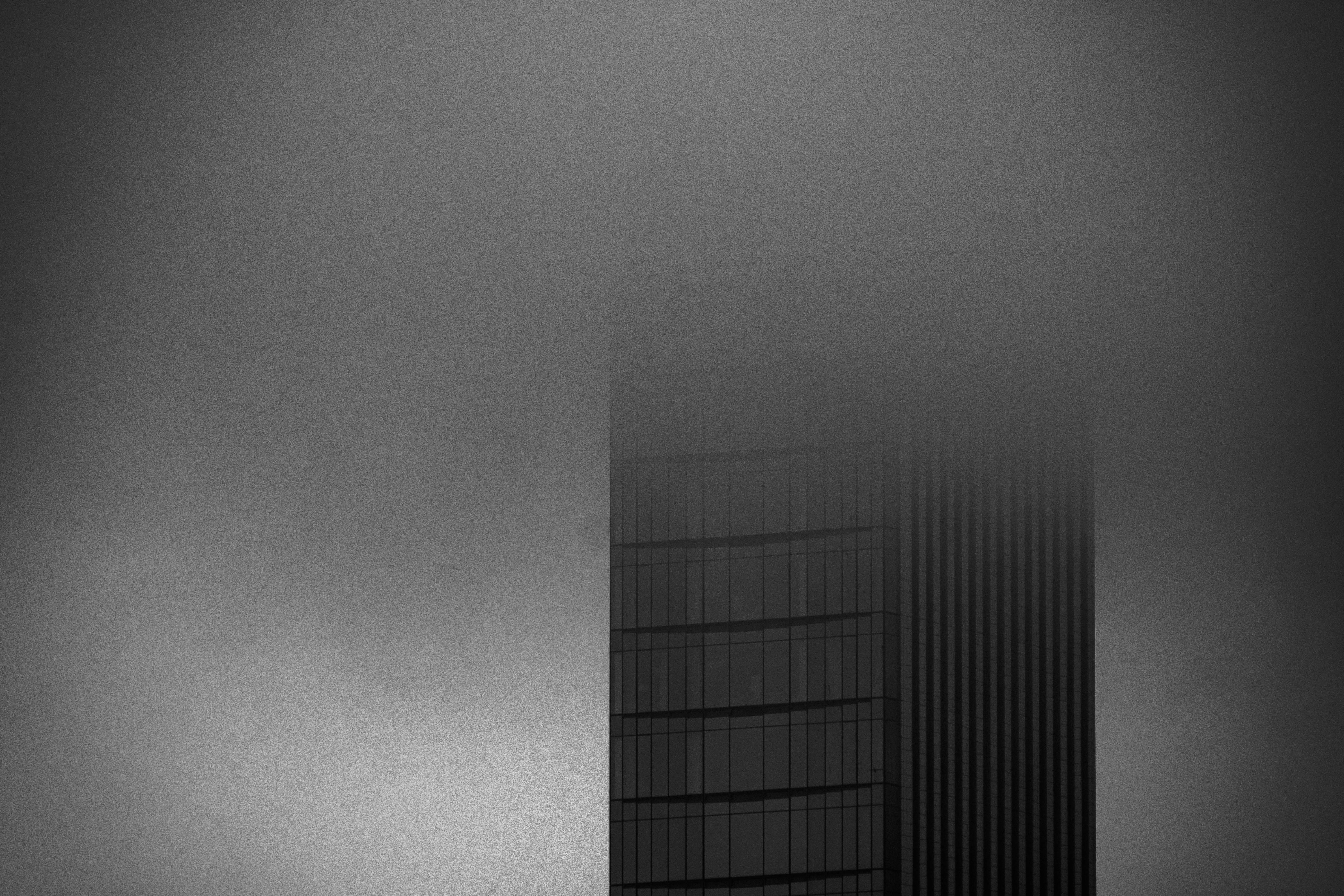 A black and white photo of a building in the fog photo – Free Building ...