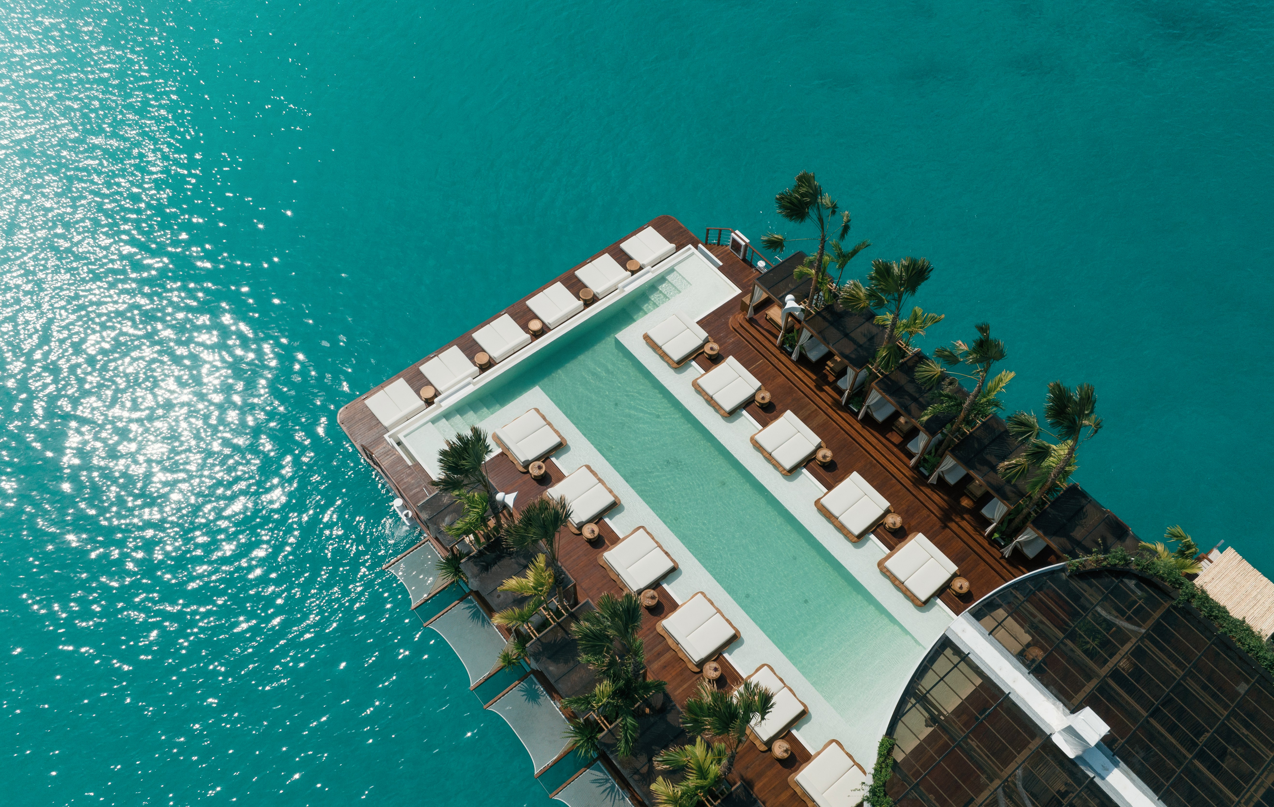 An aerial view of a resort pool with chairs and umbrellas photo – Free ...