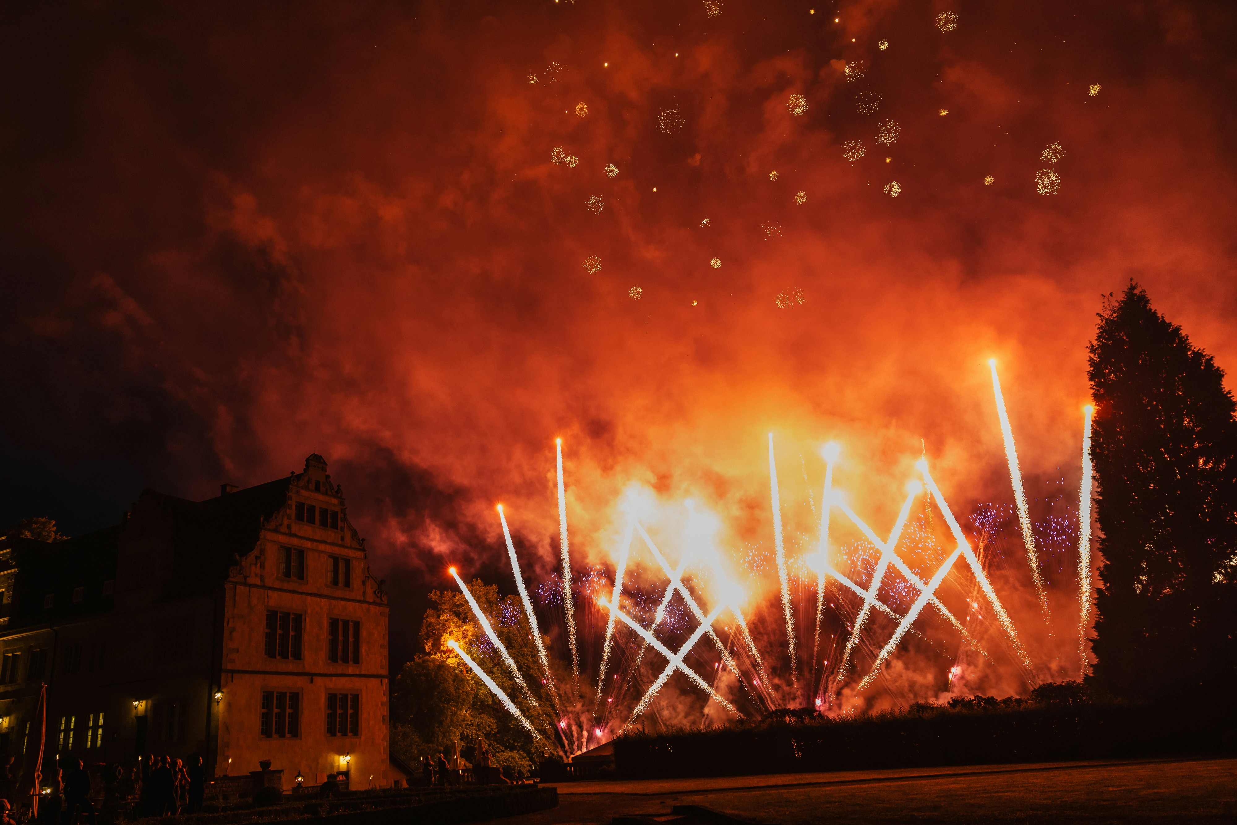 A large firework is lit up in the night sky photo – Free Building Image ...