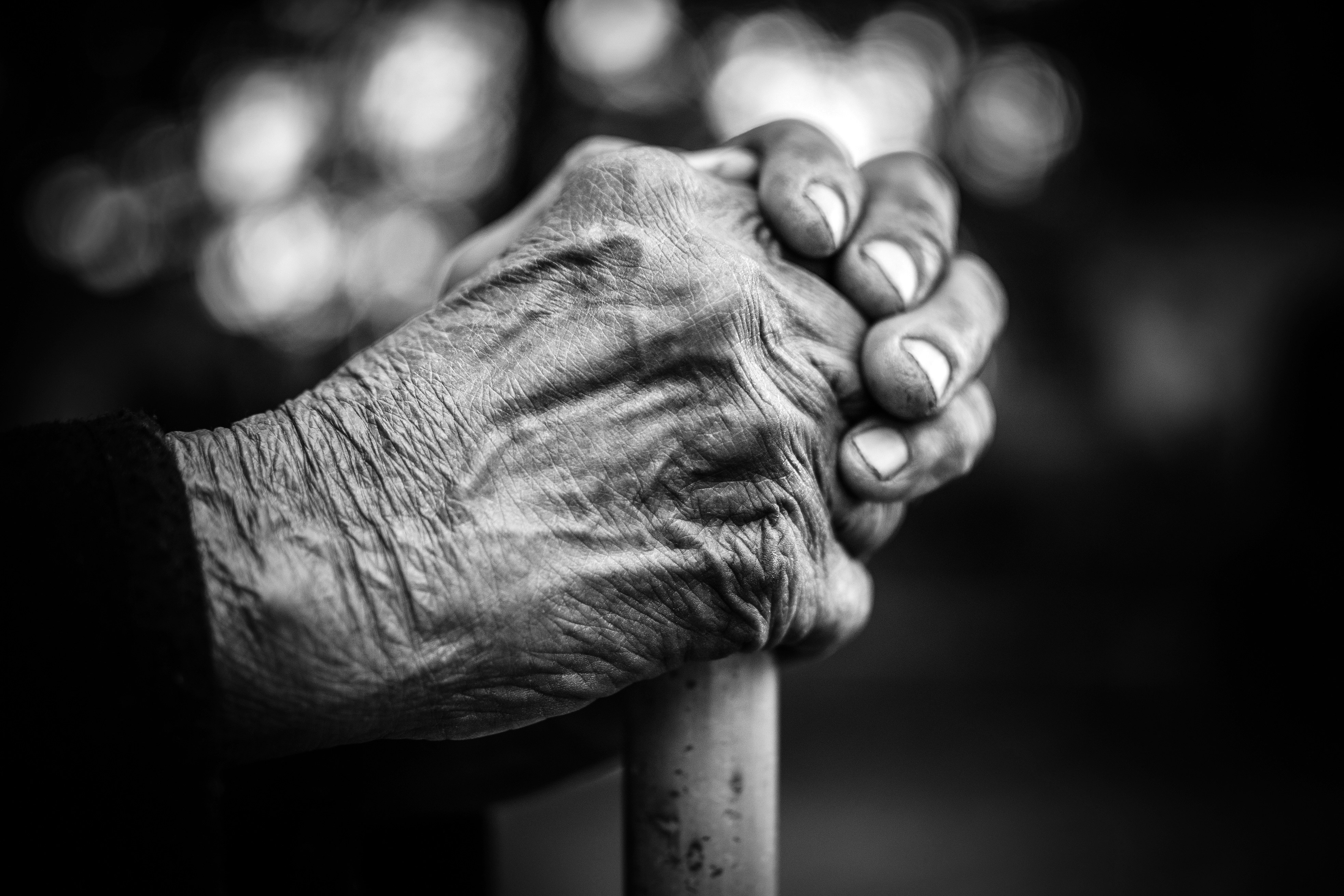 A black and white photo of a person's hand on a pole photo – Free ...