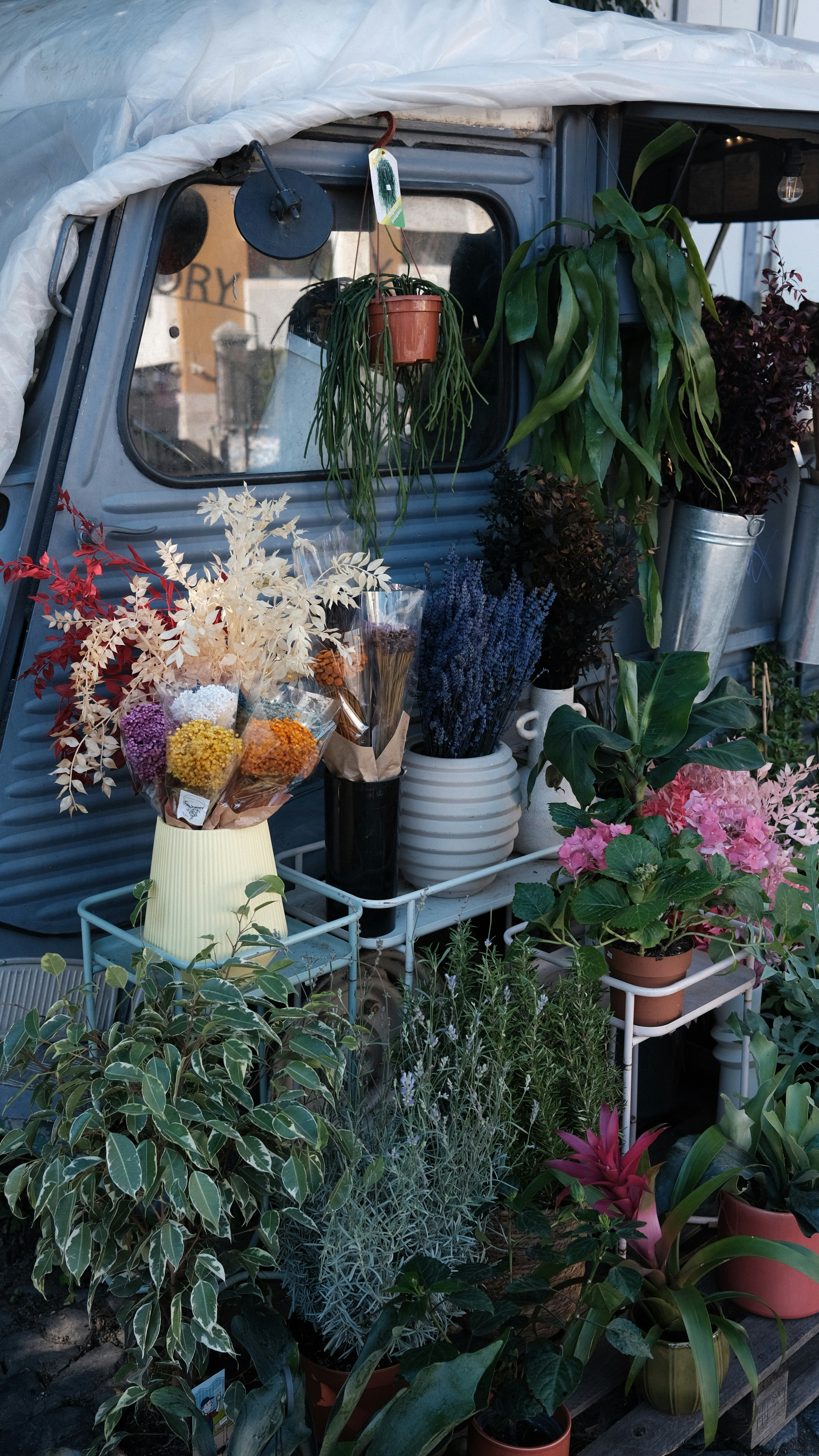 a truck with a bunch of flowers on the back of it