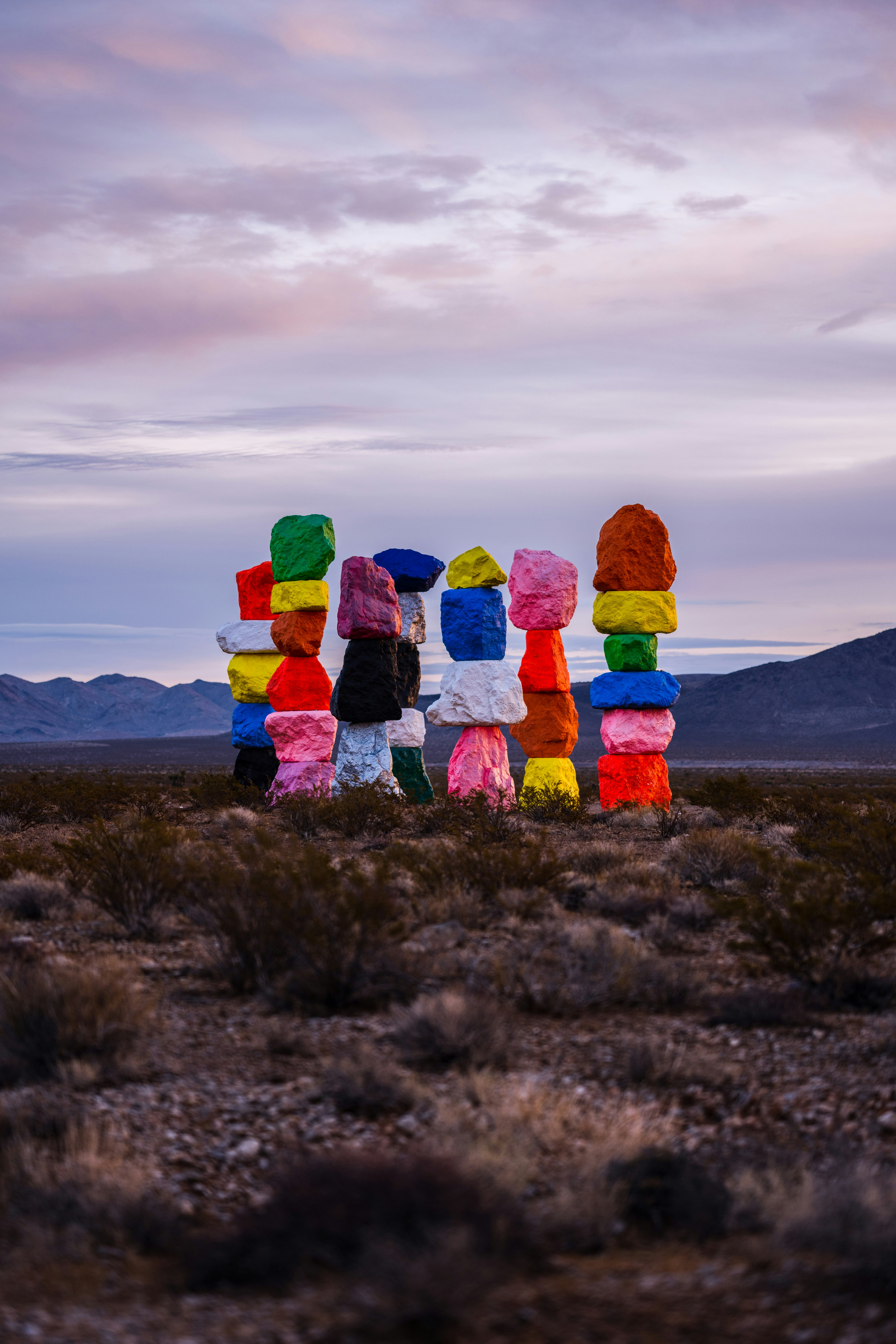Neon Cairns in the Mojave: Painted Rock Columns at Dusk