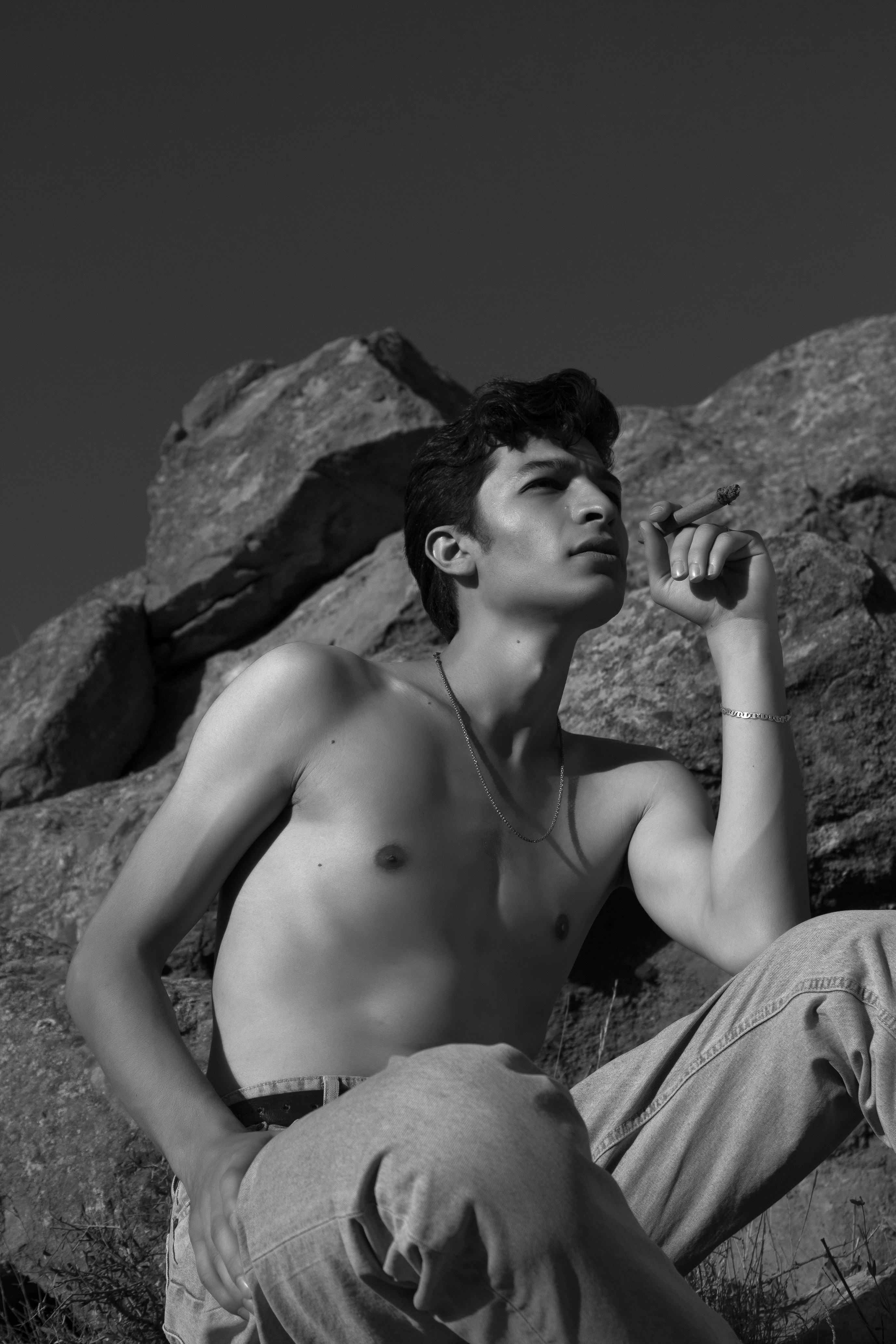 A man sitting on a rock smoking a cigarette photo – Free Tabriz Image ...