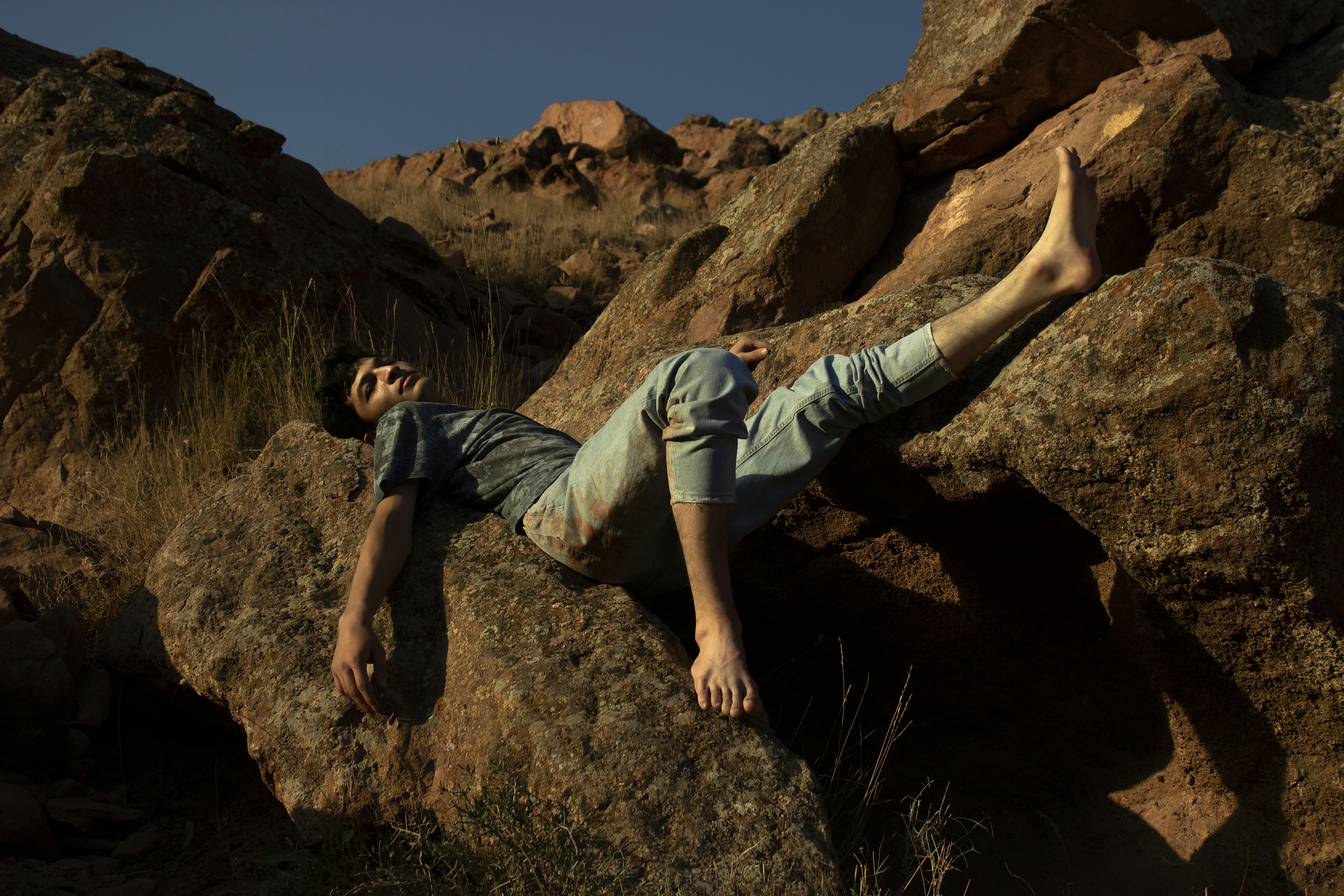 A climber Paused mid-Relax on Weathered Granite