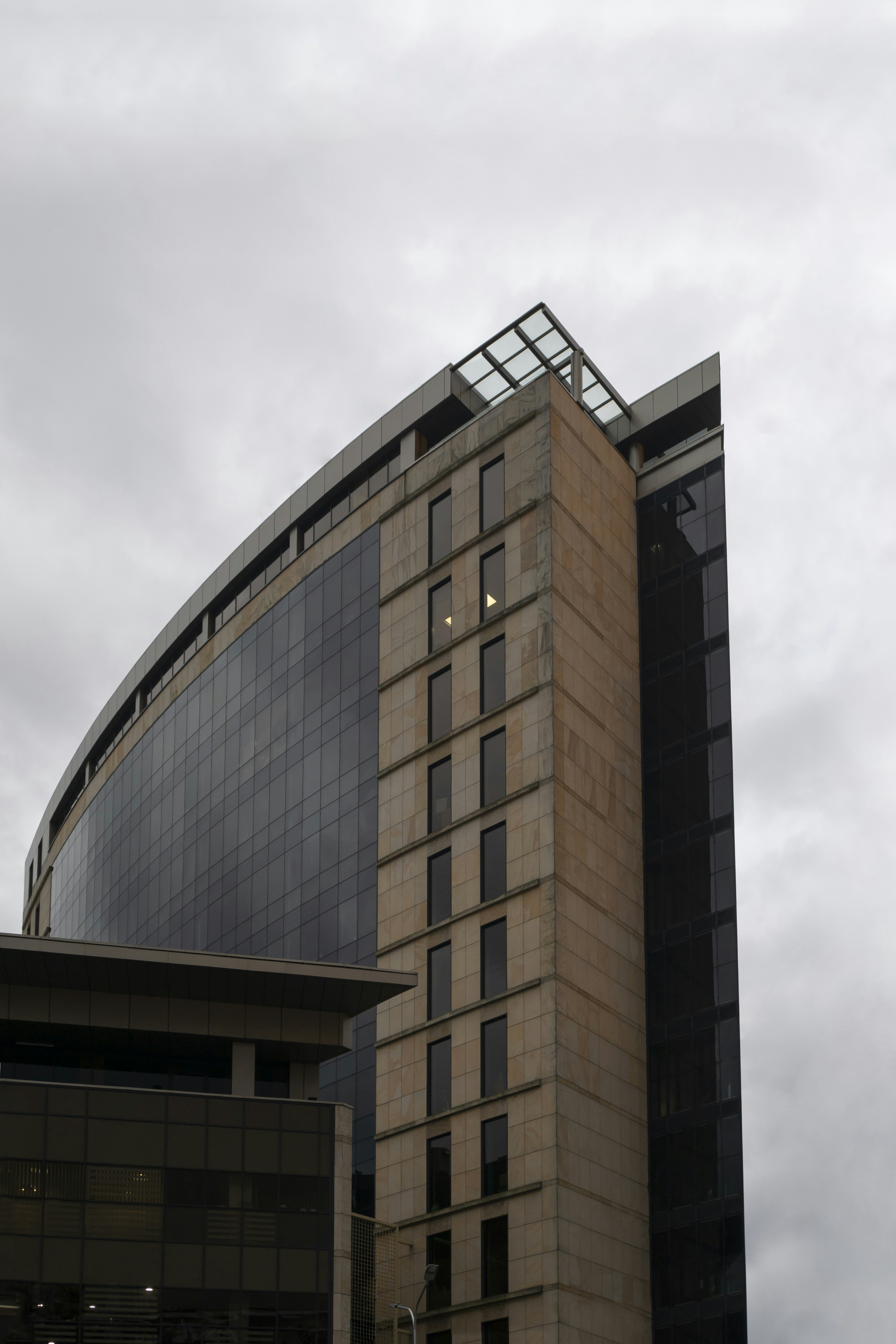 Curved Glass Tower: Geometry in Stone Under a Broad Sky