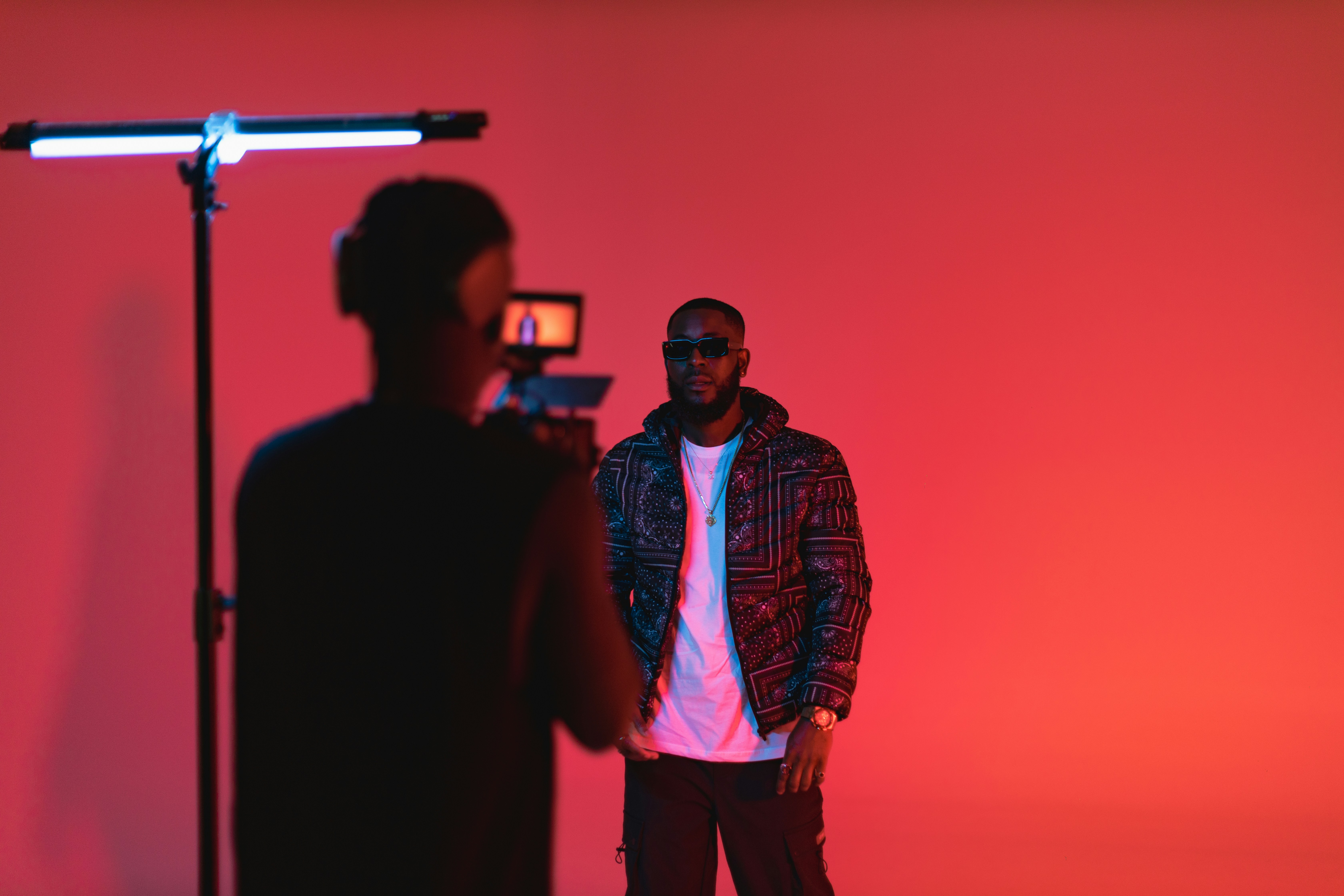 A man standing in front of a red light photo – Free Image on Unsplash