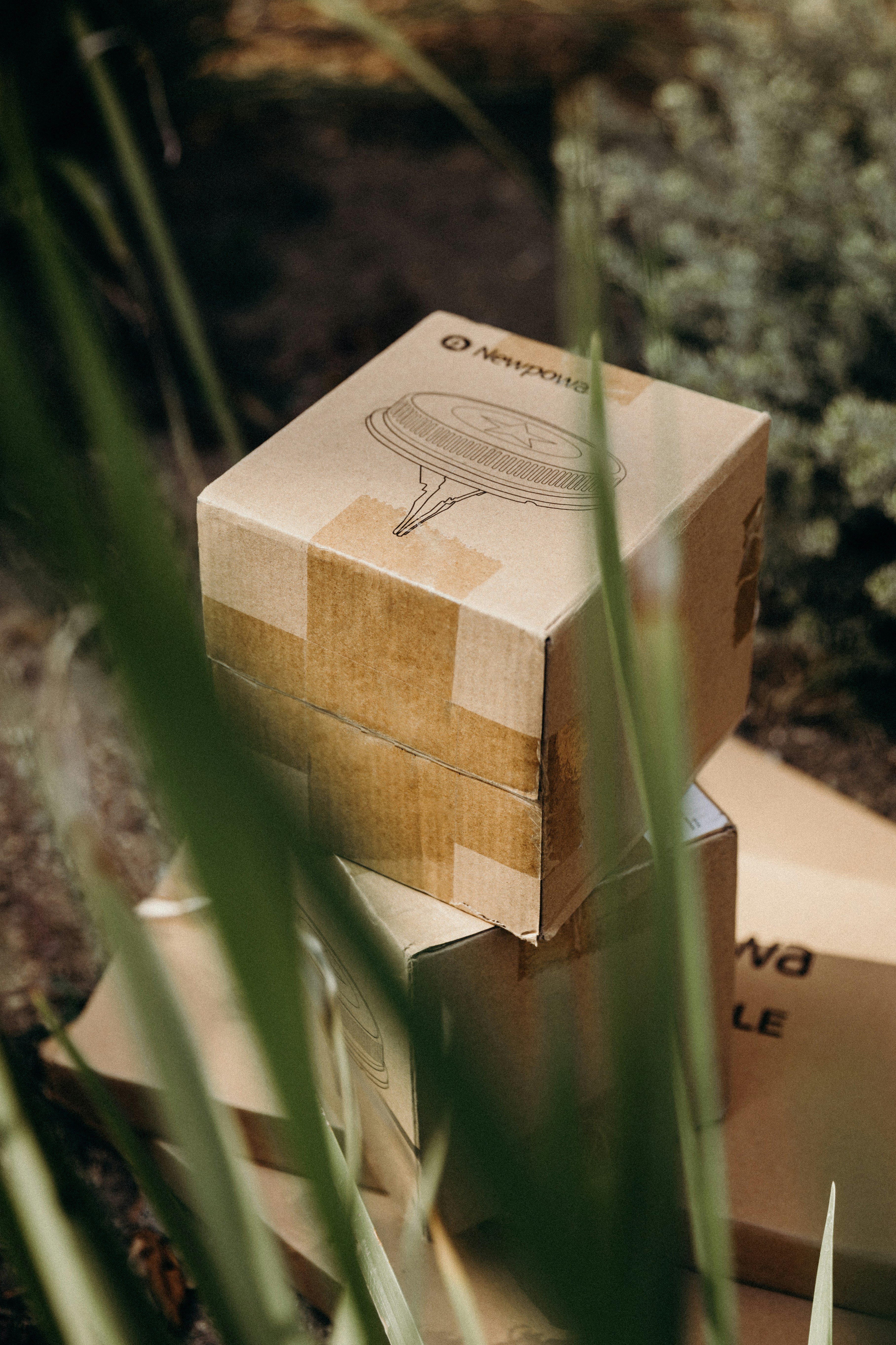 Two boxes sitting on top of each other in the grass photo – Free Box ...
