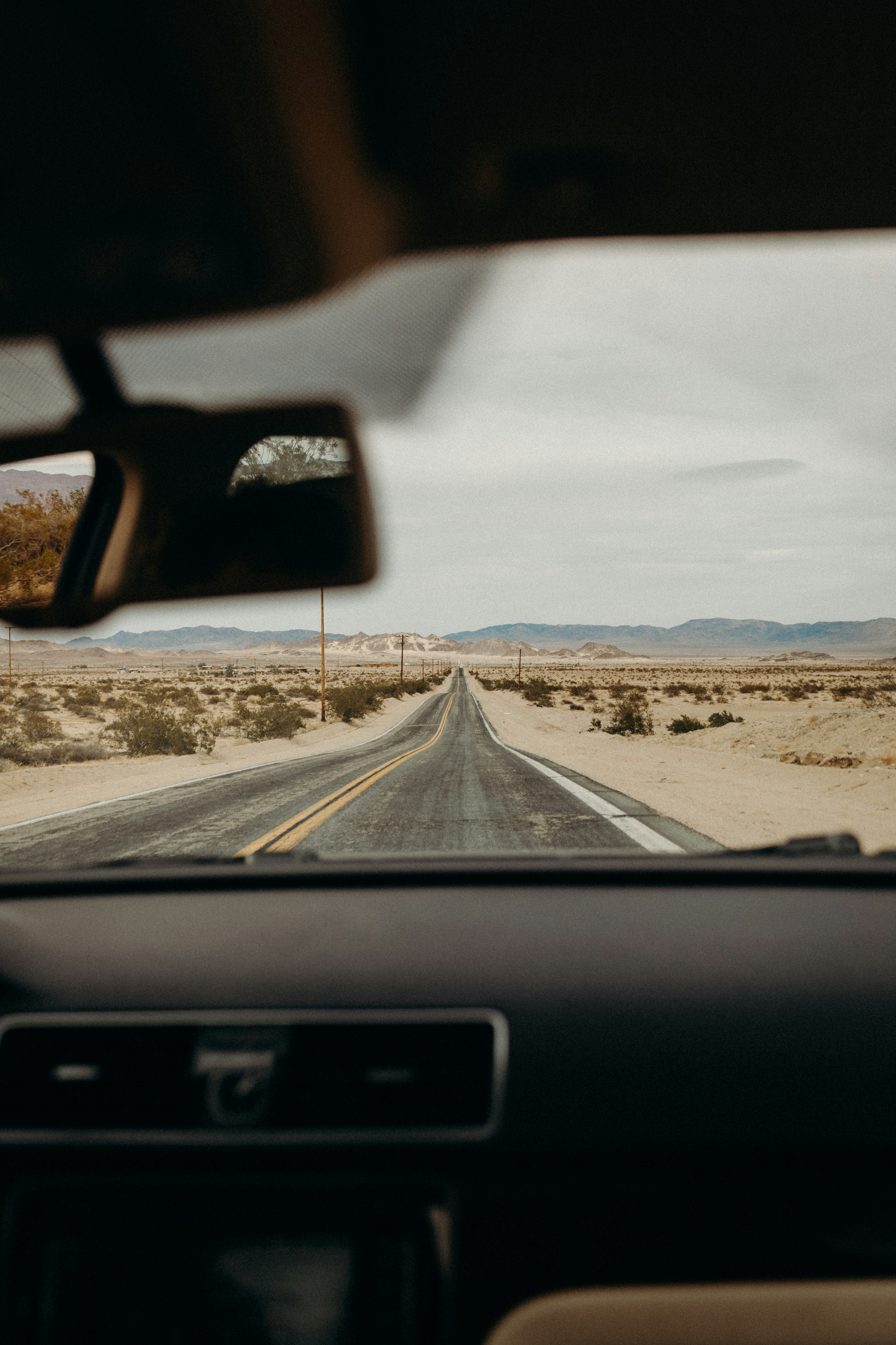 A view of a desert road from inside a car photo – Free Car Image on ...