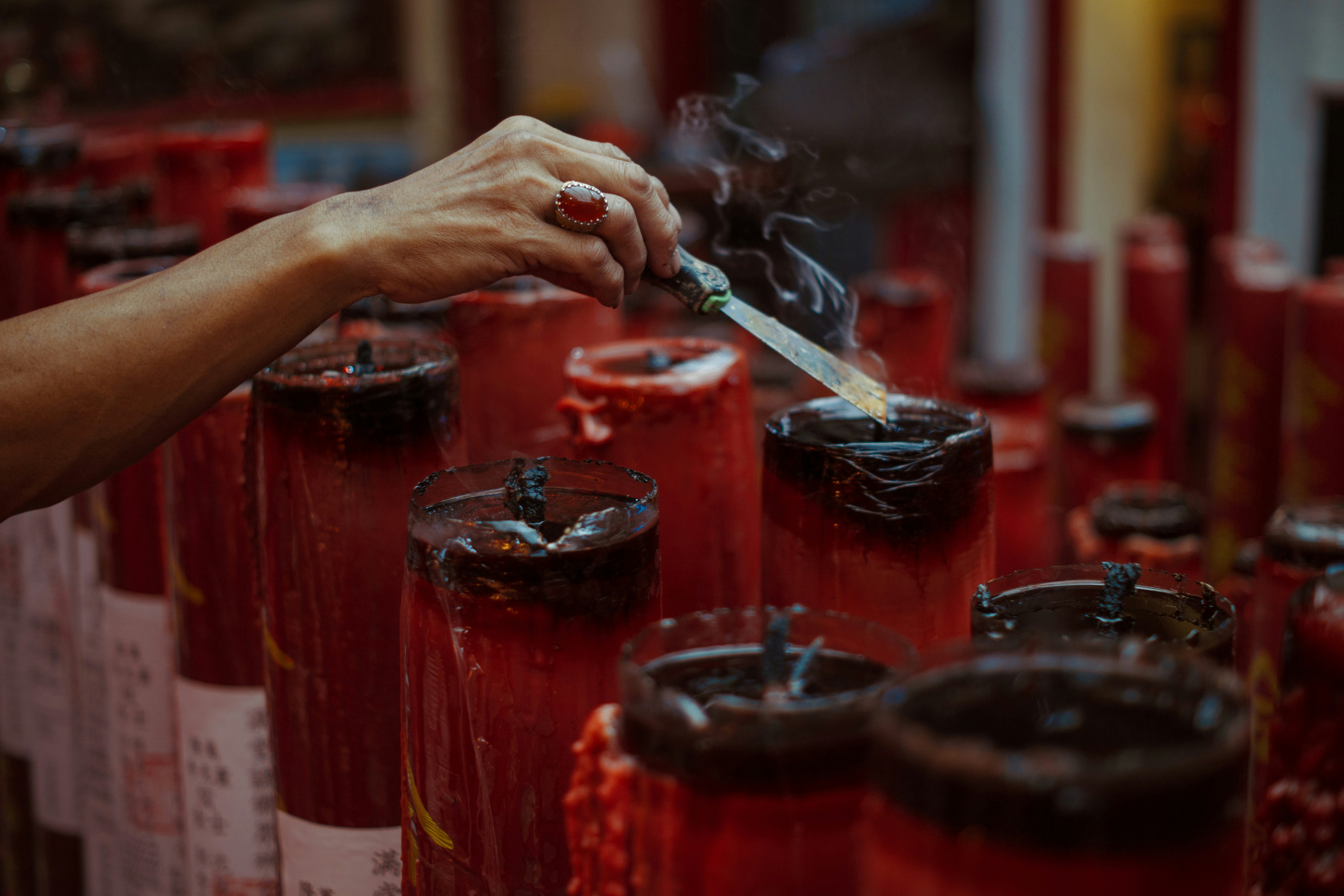 Candle-Capred Gesture: A Hand Drift over Red Vessels