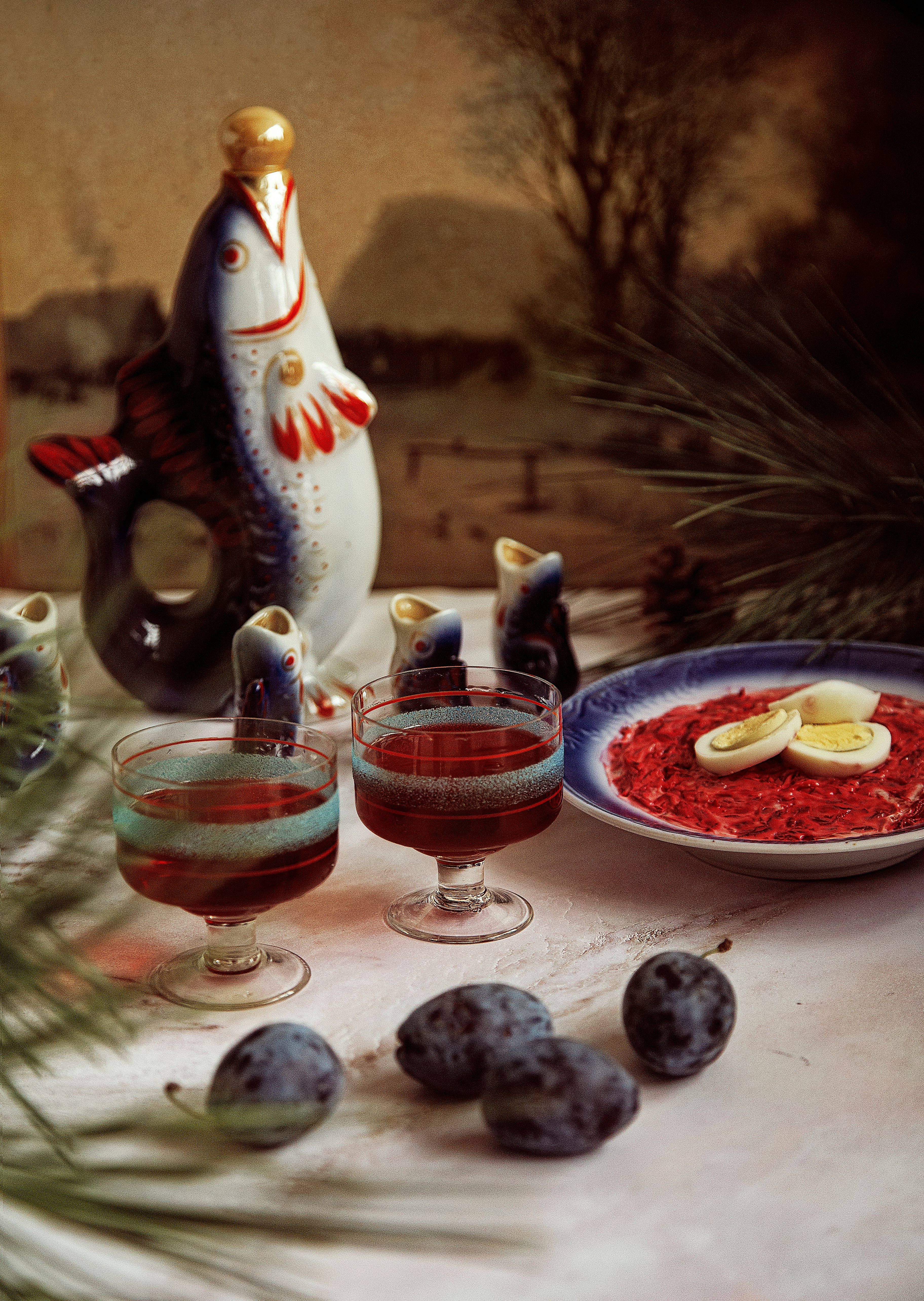 a table topped with glasses and plates of food