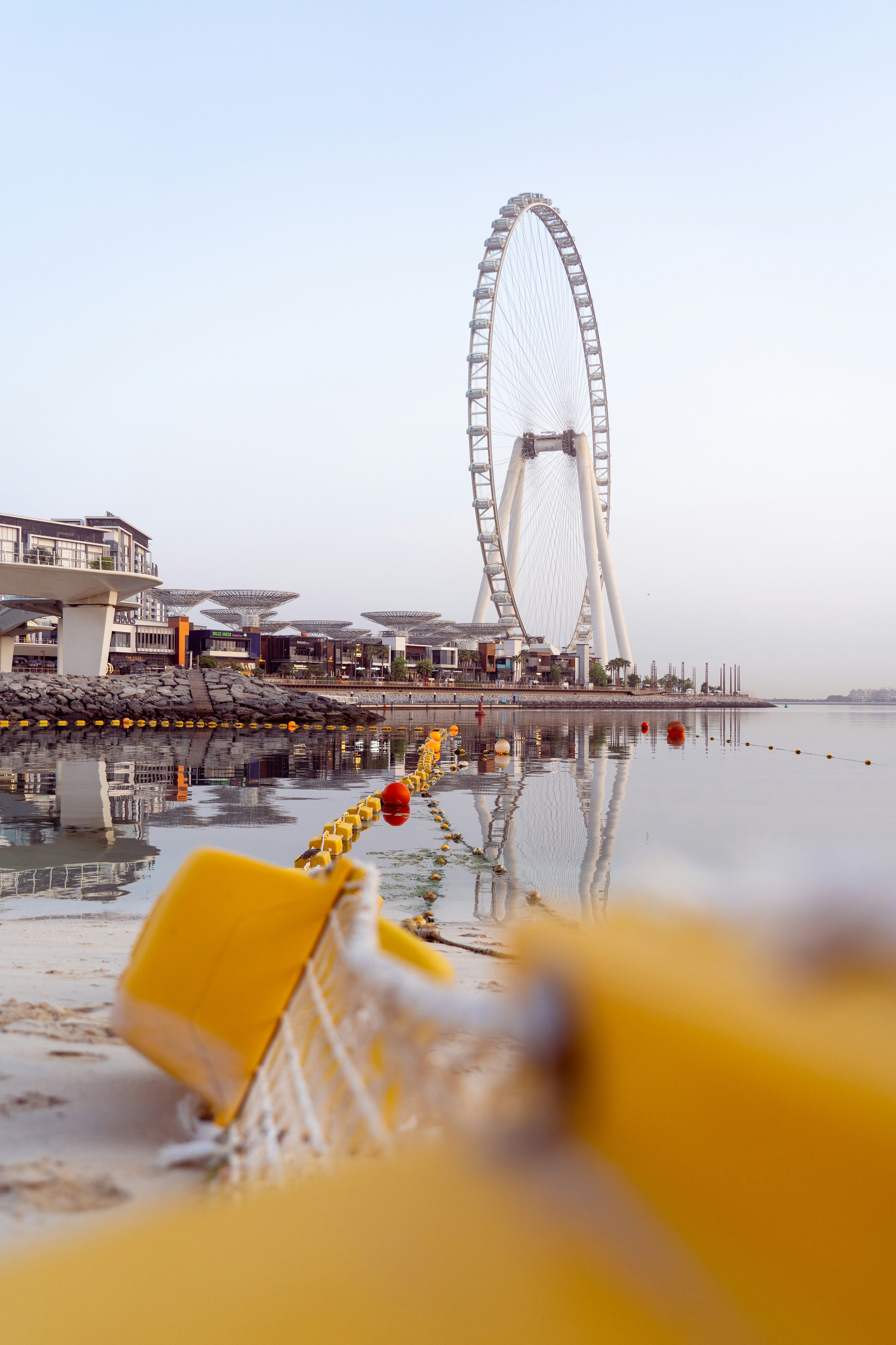 Spoked sentinel over a glassy harbor at dawn