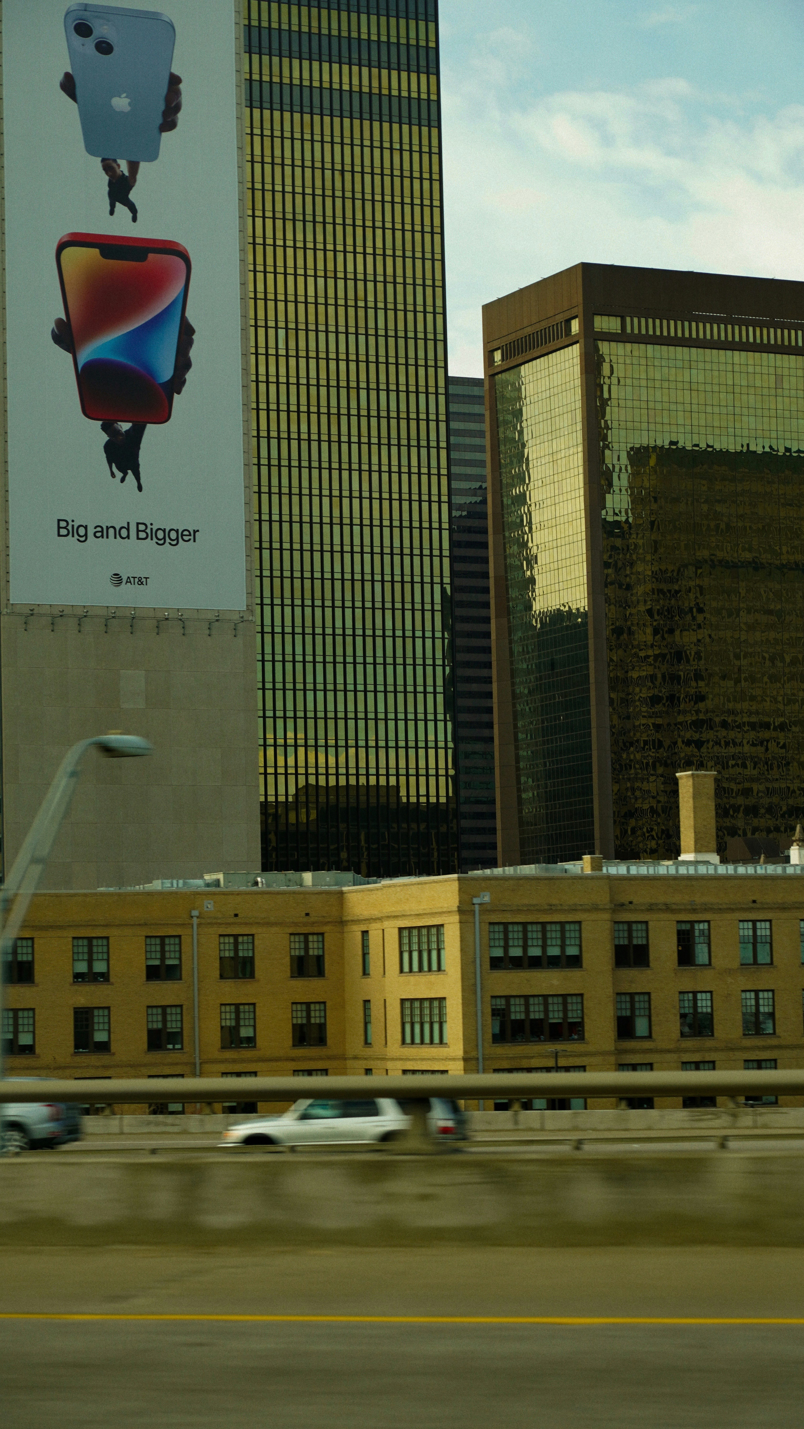 A large building with a big and bigger advertisement on it's side photo ...