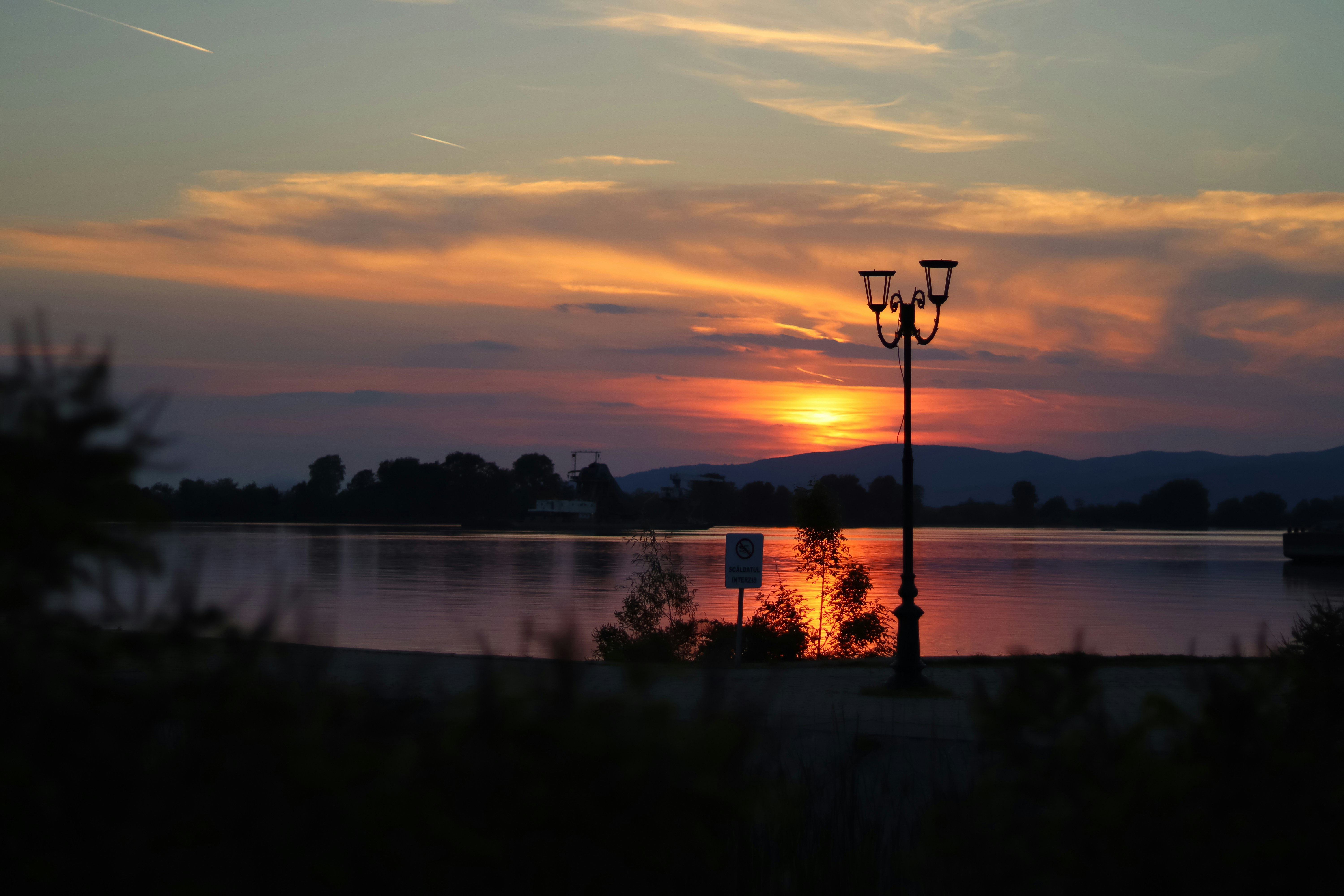 Sunset Silhouette by the Lake: Lantern on the Horizon