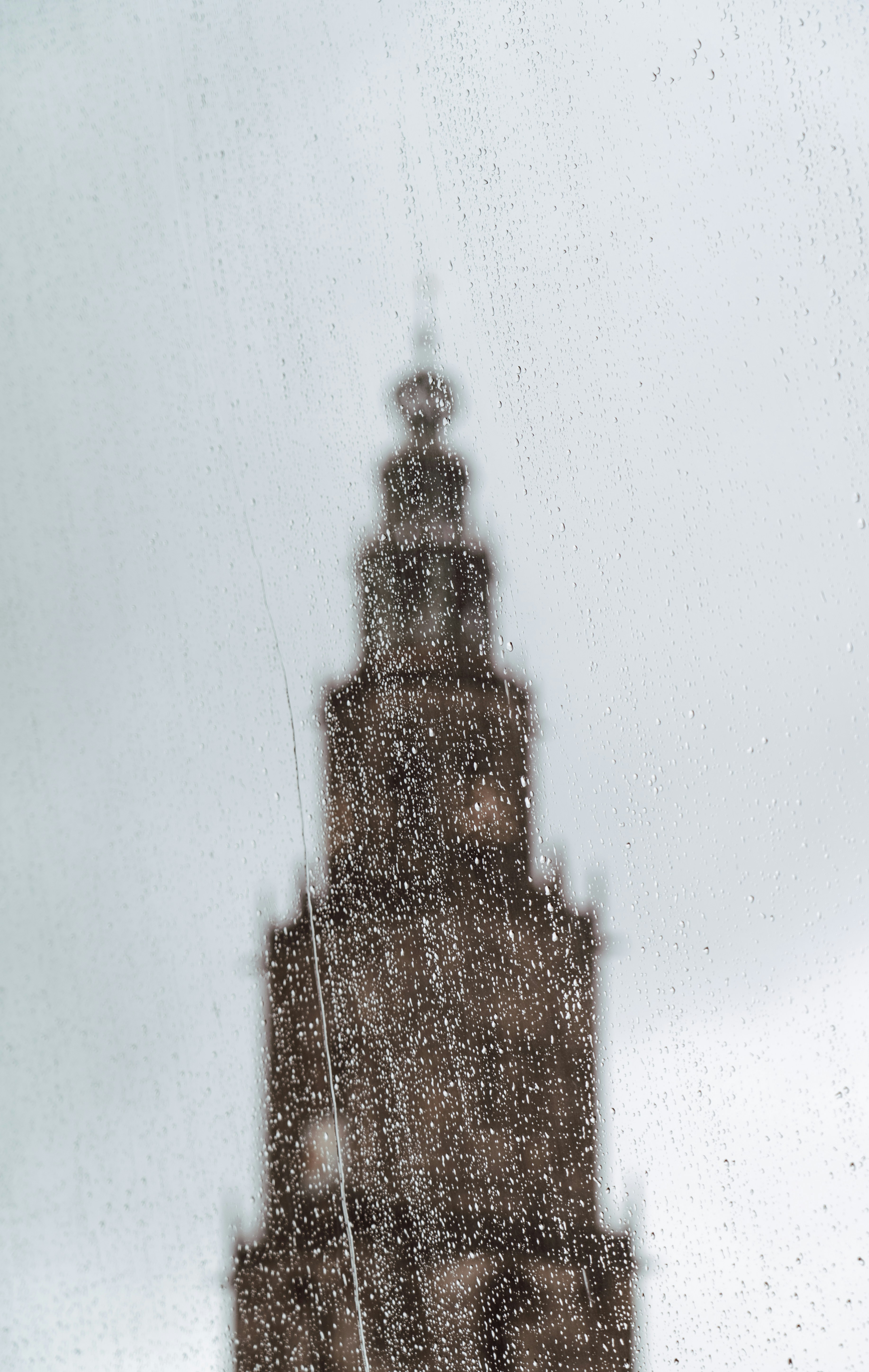 Towers of Rain: A Fogged Facade Through Glass