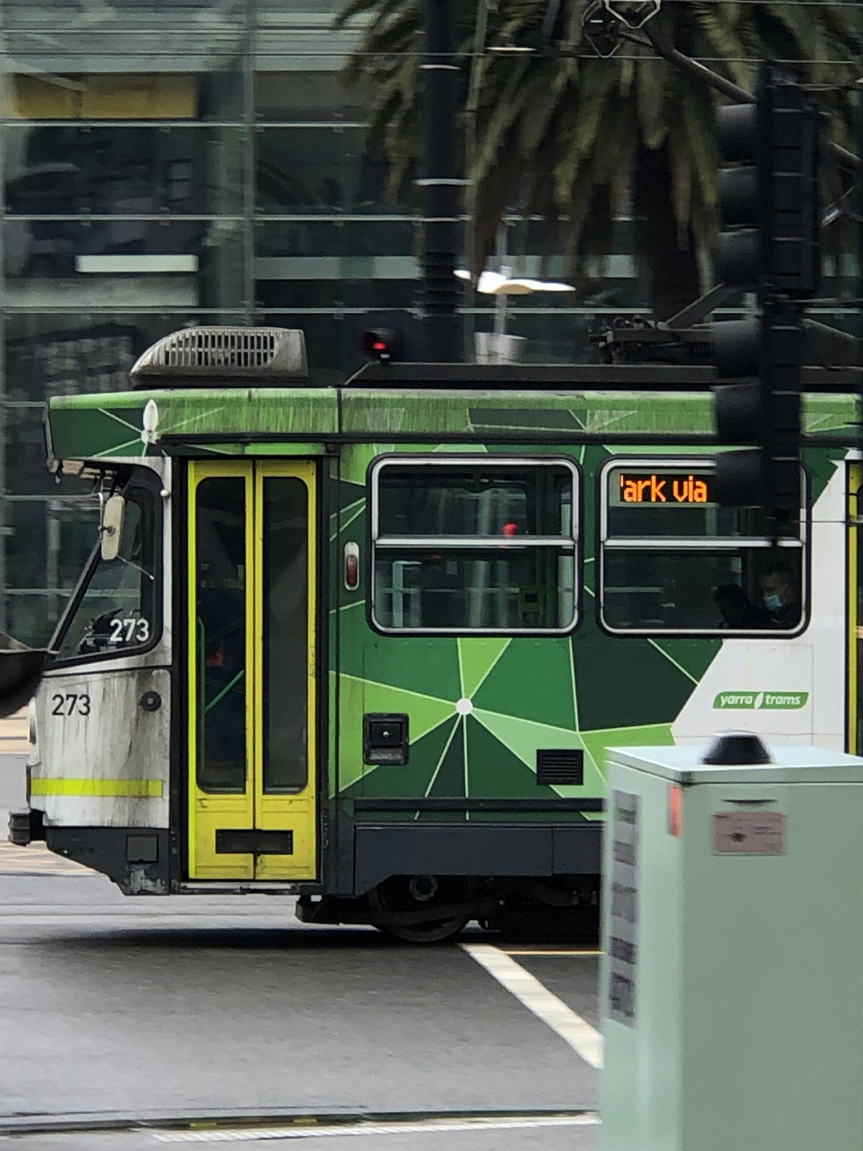 A green and yellow bus driving down a street photo – Free Image on Unsplash
