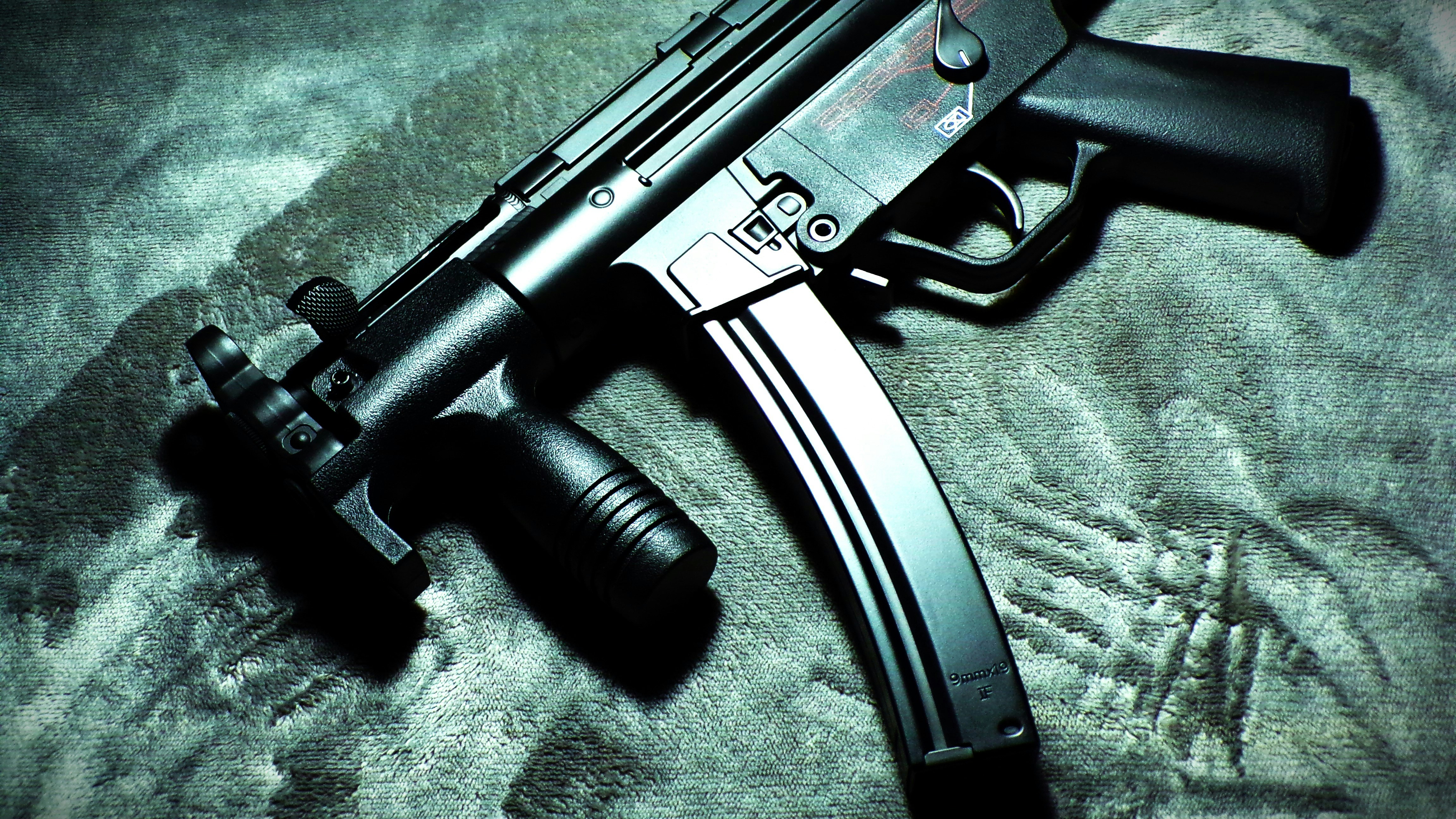 A close up of a gun laying on a bed photo – Free Firearm Image on Unsplash