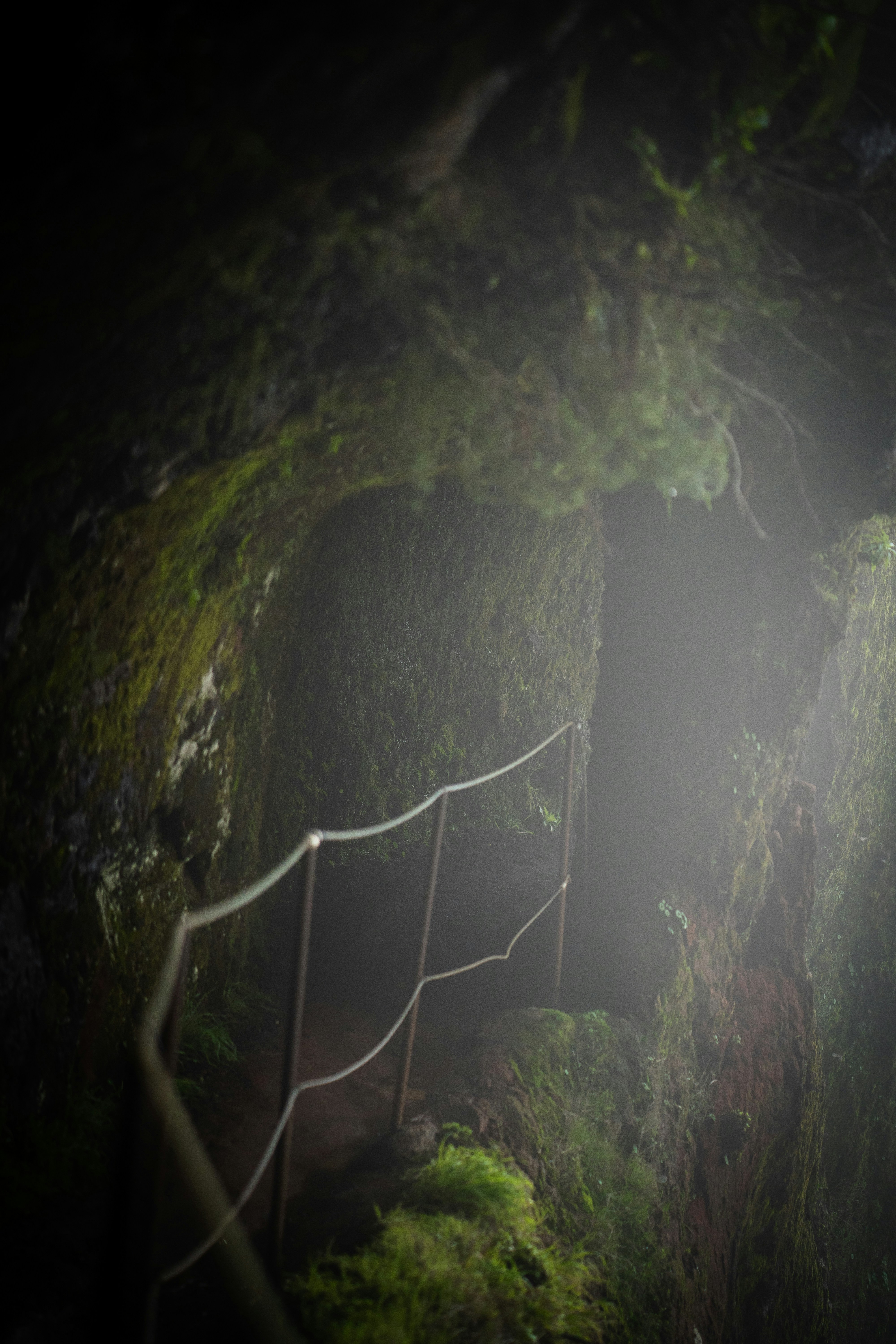 A light shines through the fog in a dark cave photo – Free Land Image ...