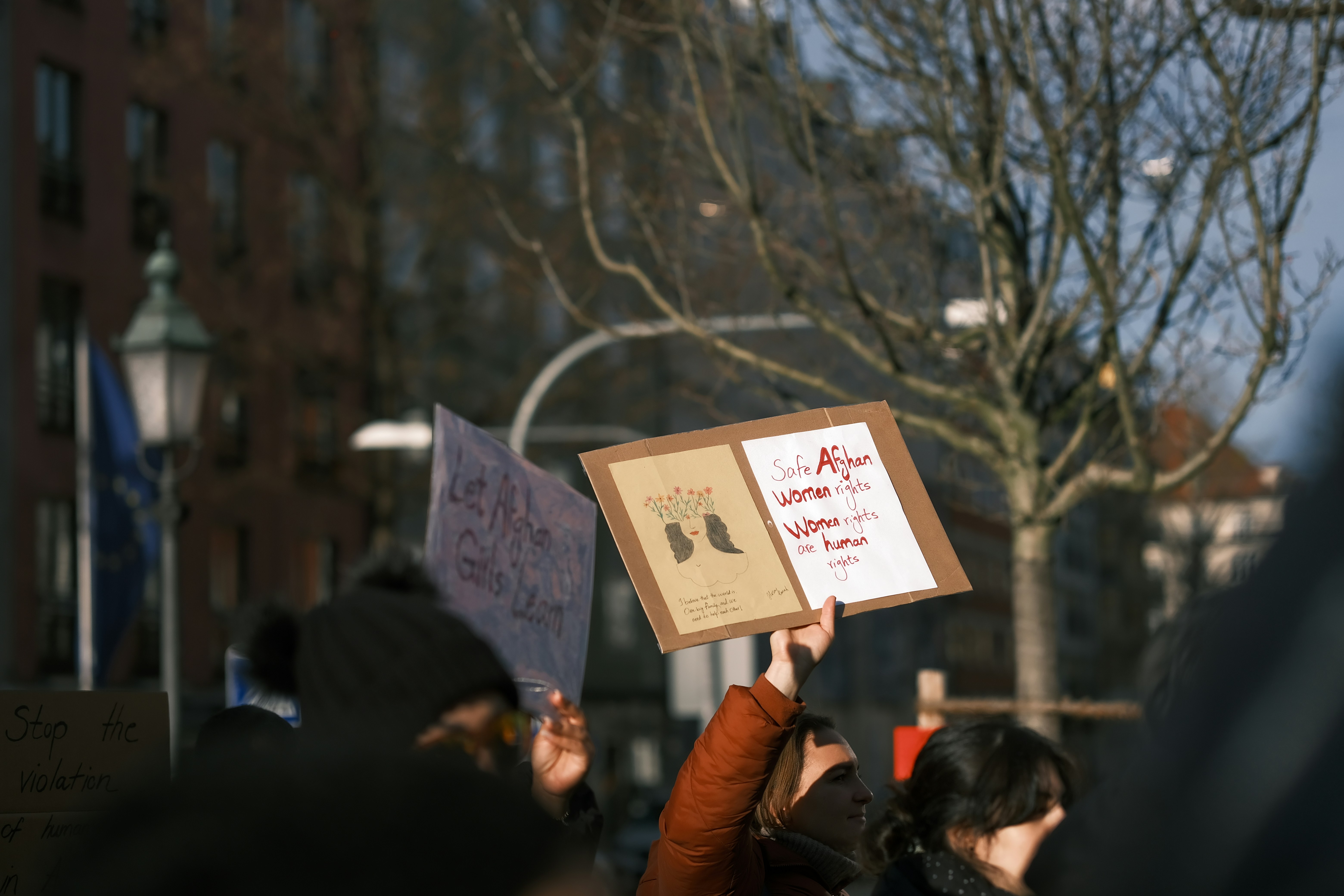 A group of people holding up signs in the air photo – Free Munich Image ...