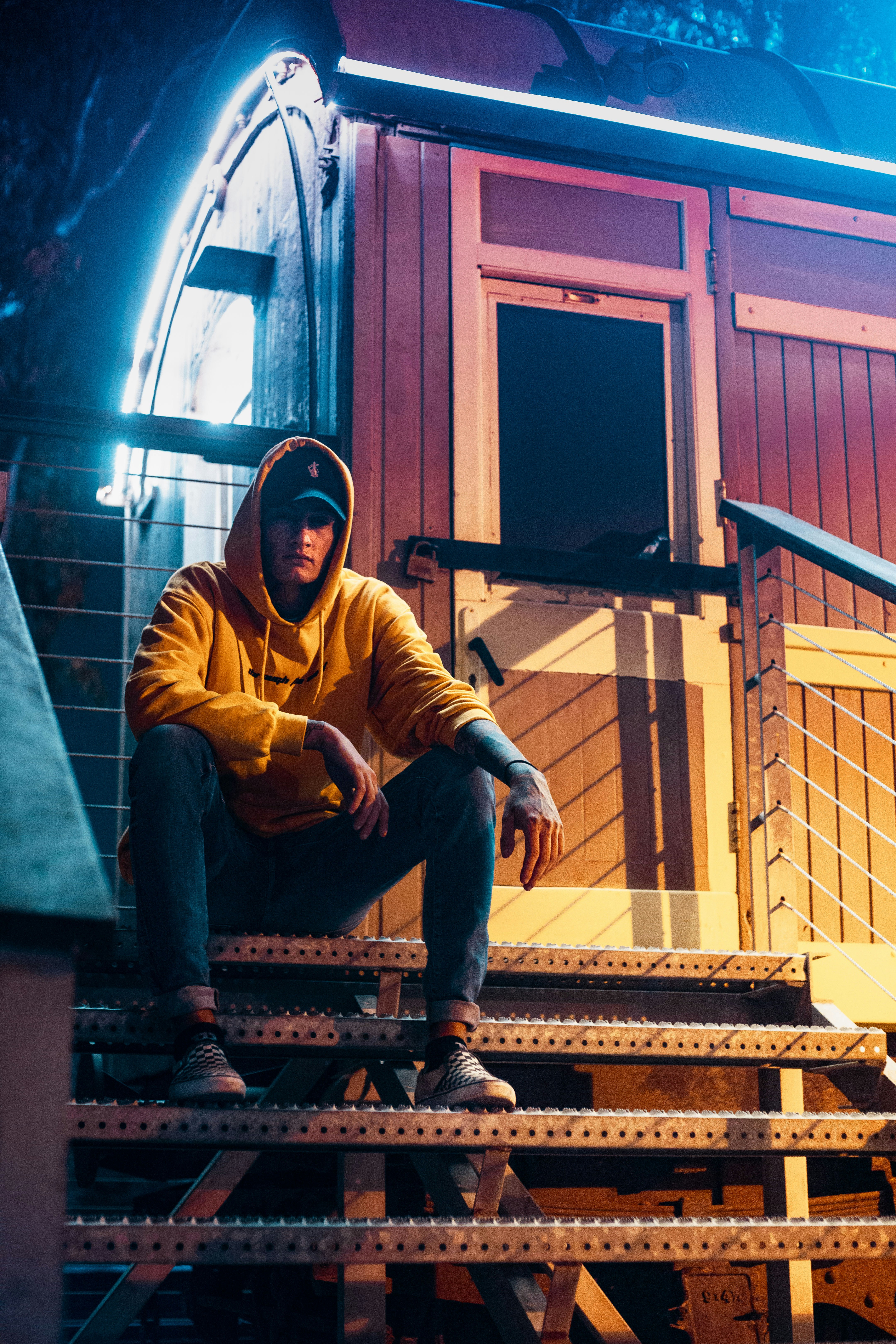 CTY Neon Shadow: A Hooded Figure on Industrial Stairs