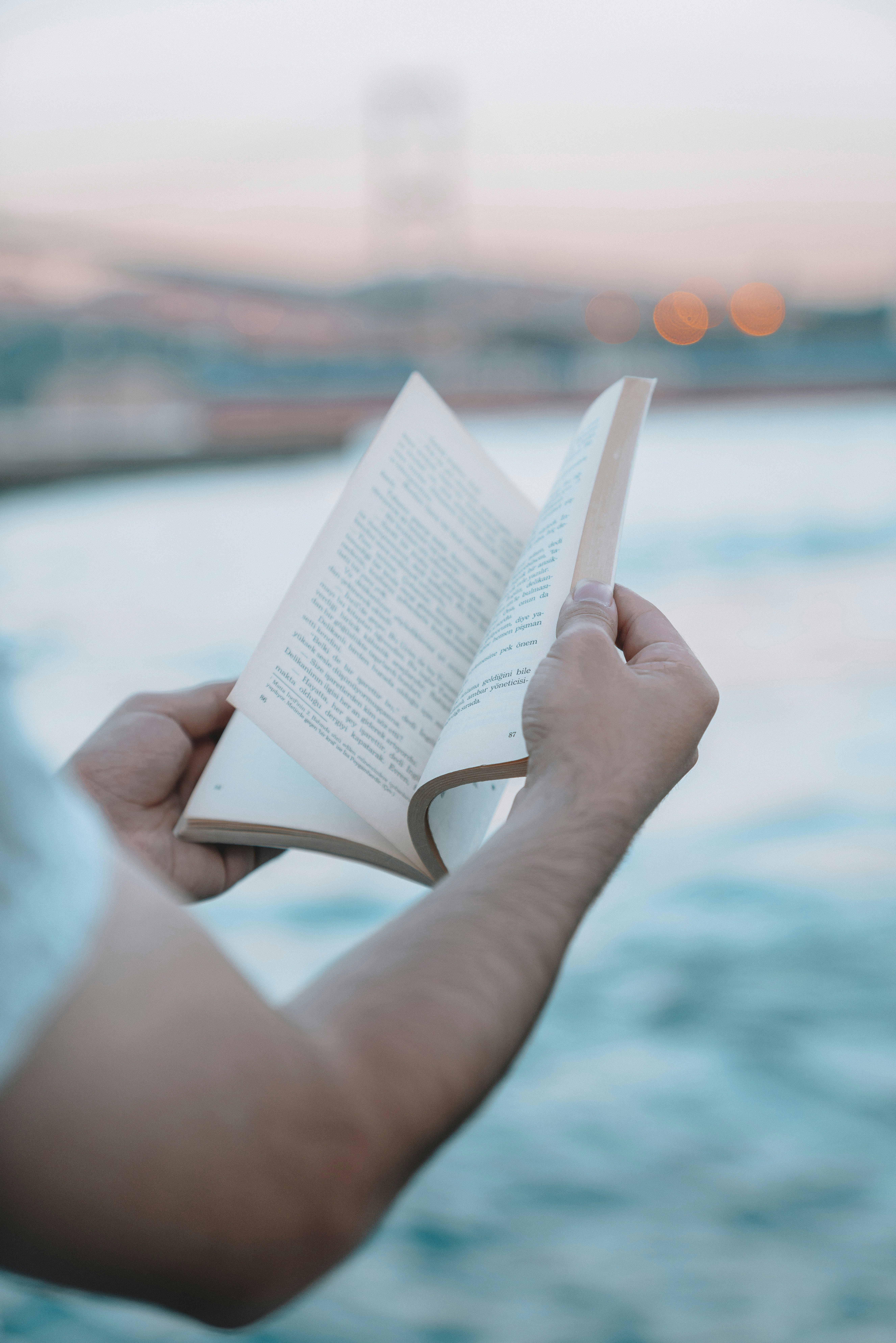 A person holding a book in their hands photo – Free Sea Image on Unsplash
