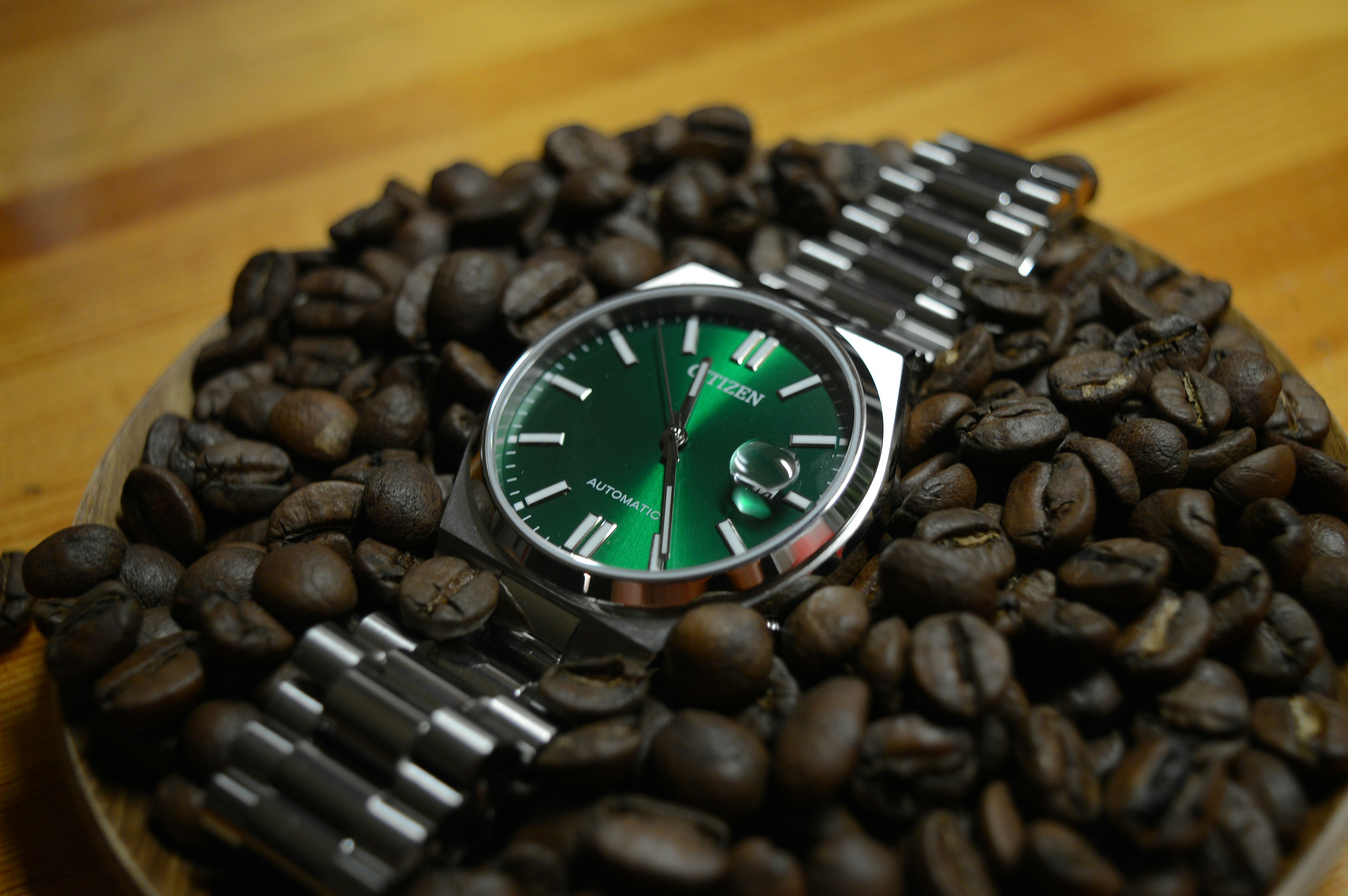 A watch sitting on top of a pile of coffee beans photo – Free Watches ...