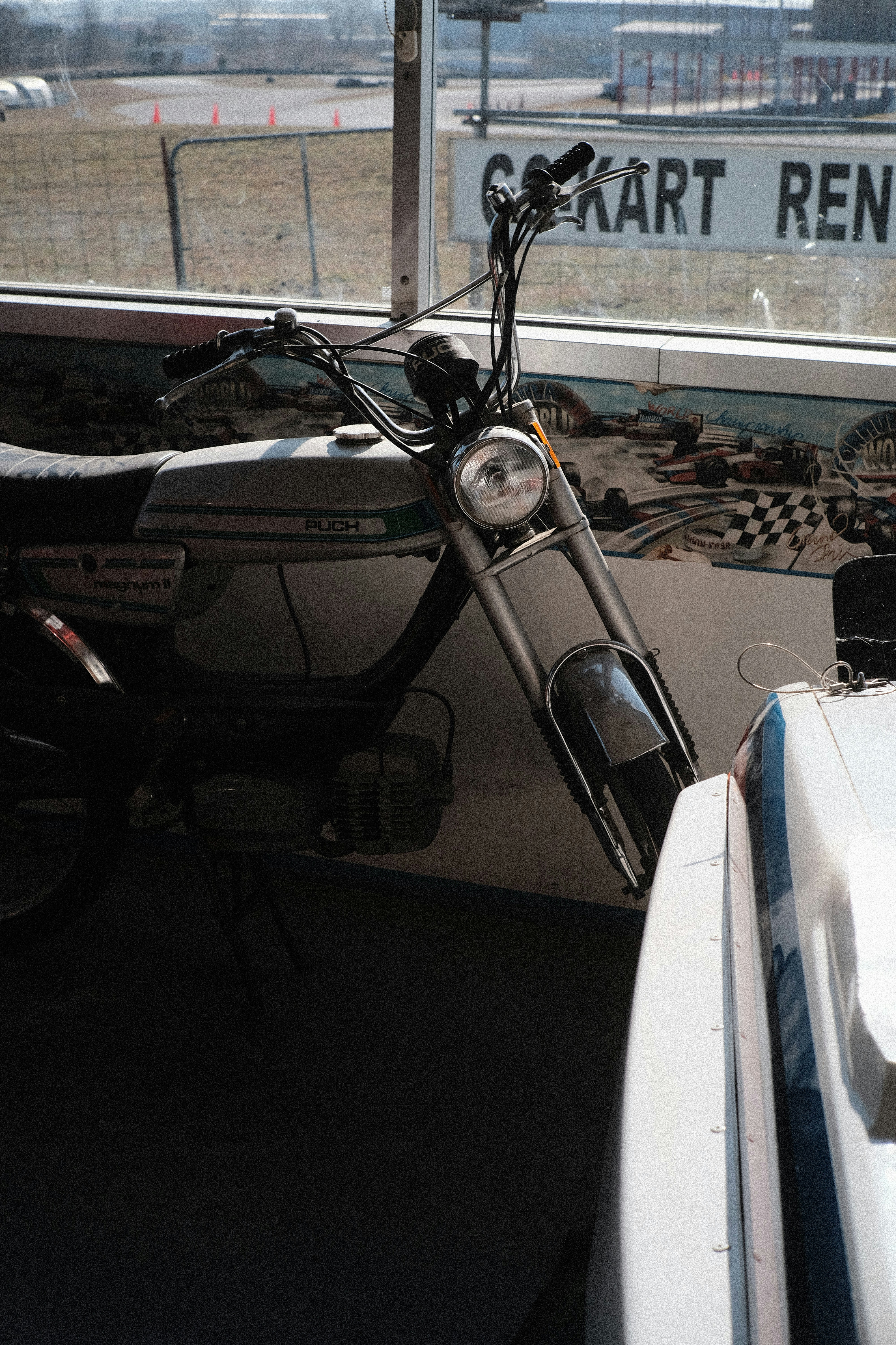 A motorcycle parked in front of a window photo – Free Image on Unsplash